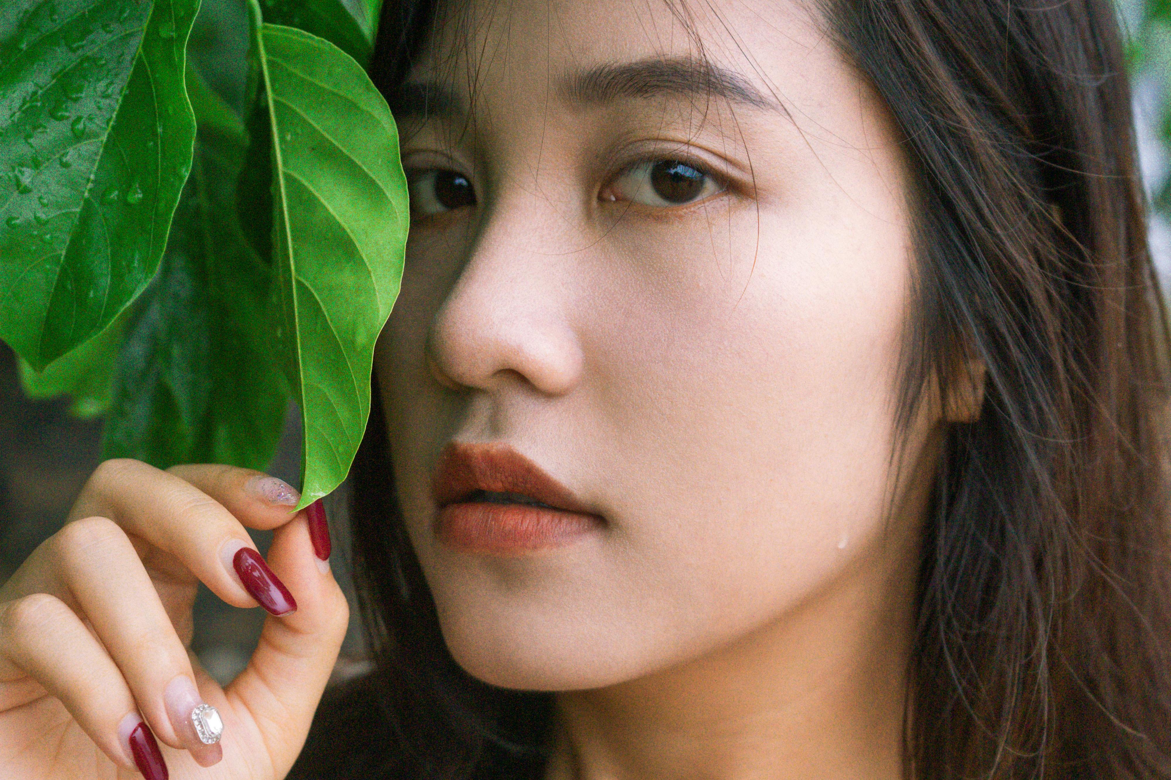 Portrait of a Young Woman Touching a Tree Lea · Free Stock Photo