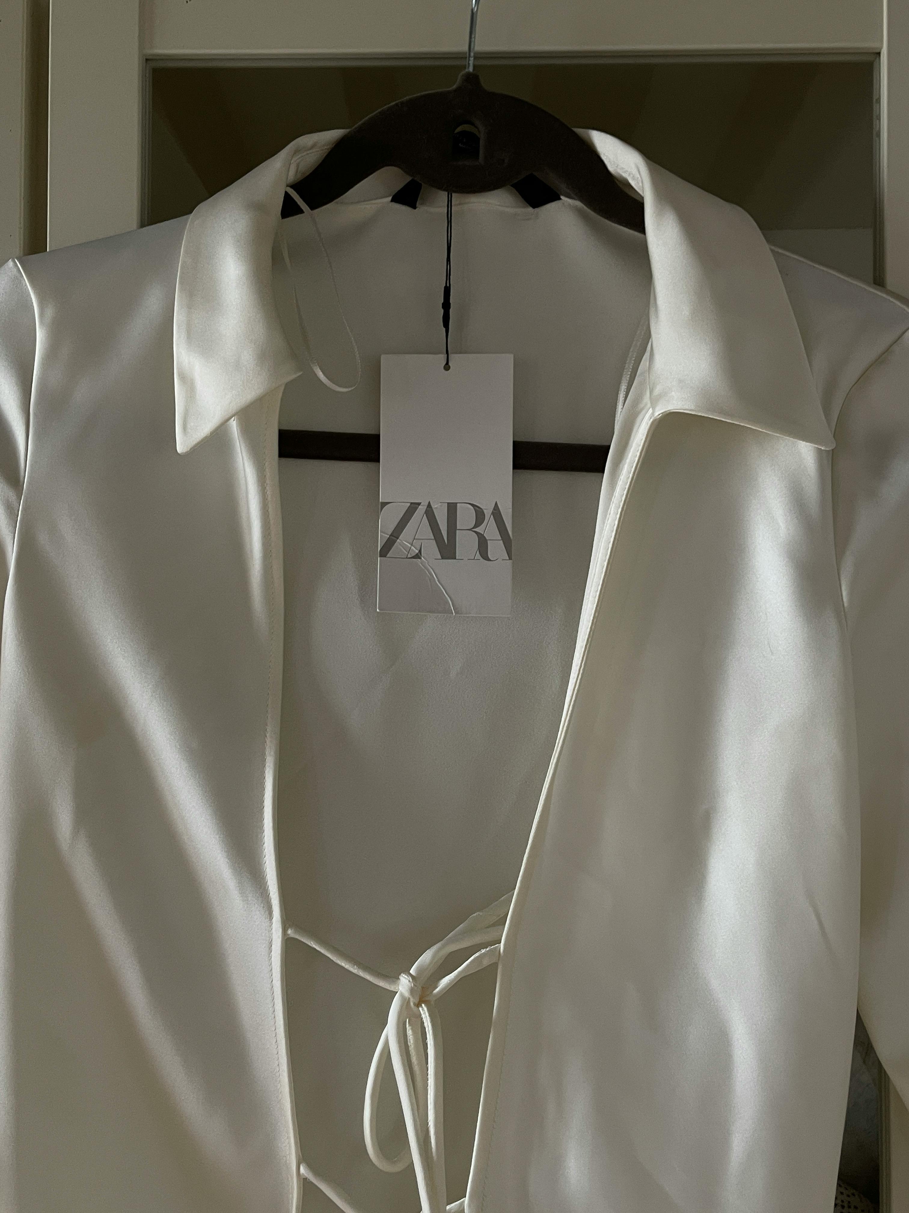 White Satin Shirt from Zara Hanging on a Hanger · Free Stock Photo
