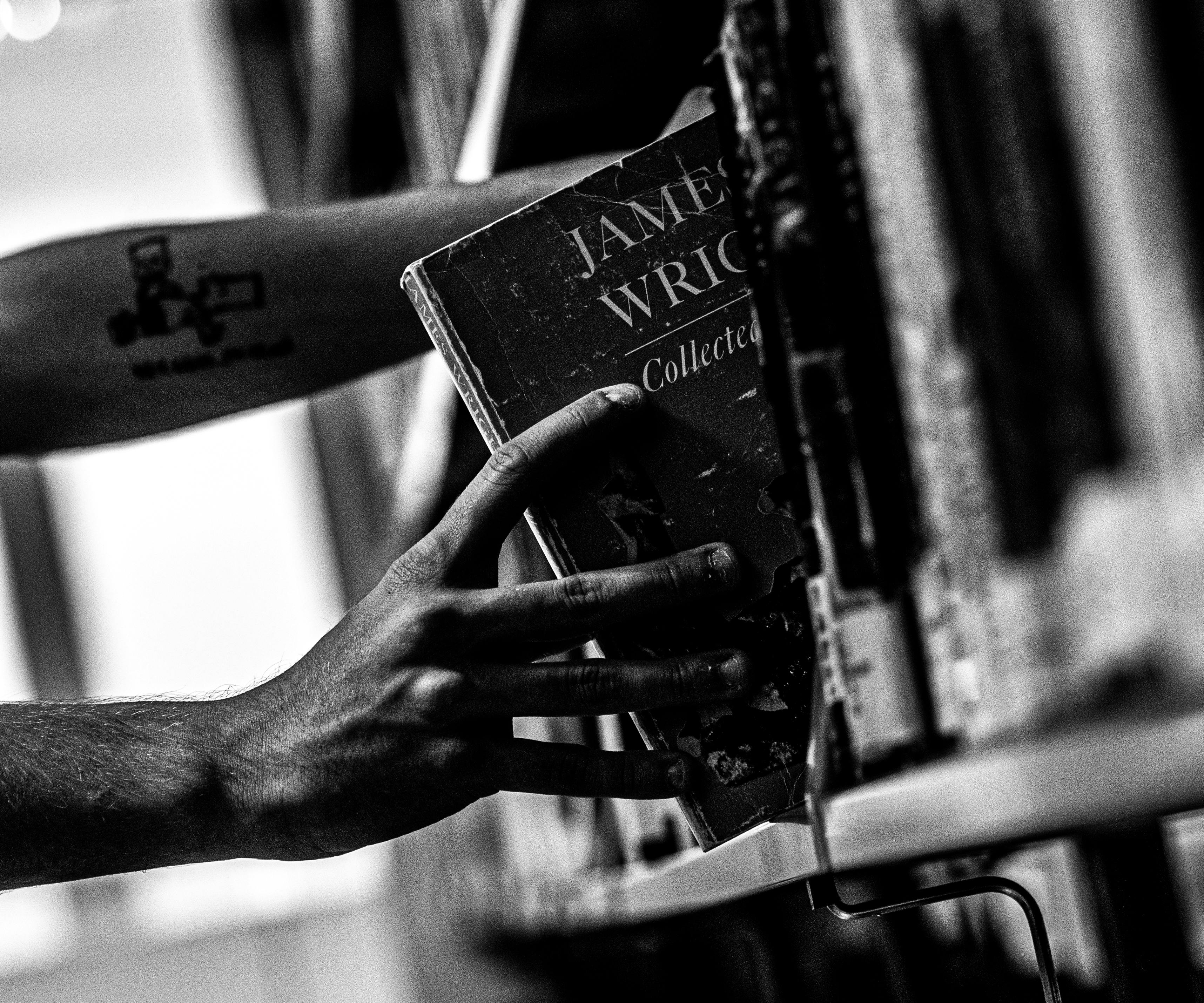 Close-up of a Man Taking a Book from the Shelf in a Library · Free ...