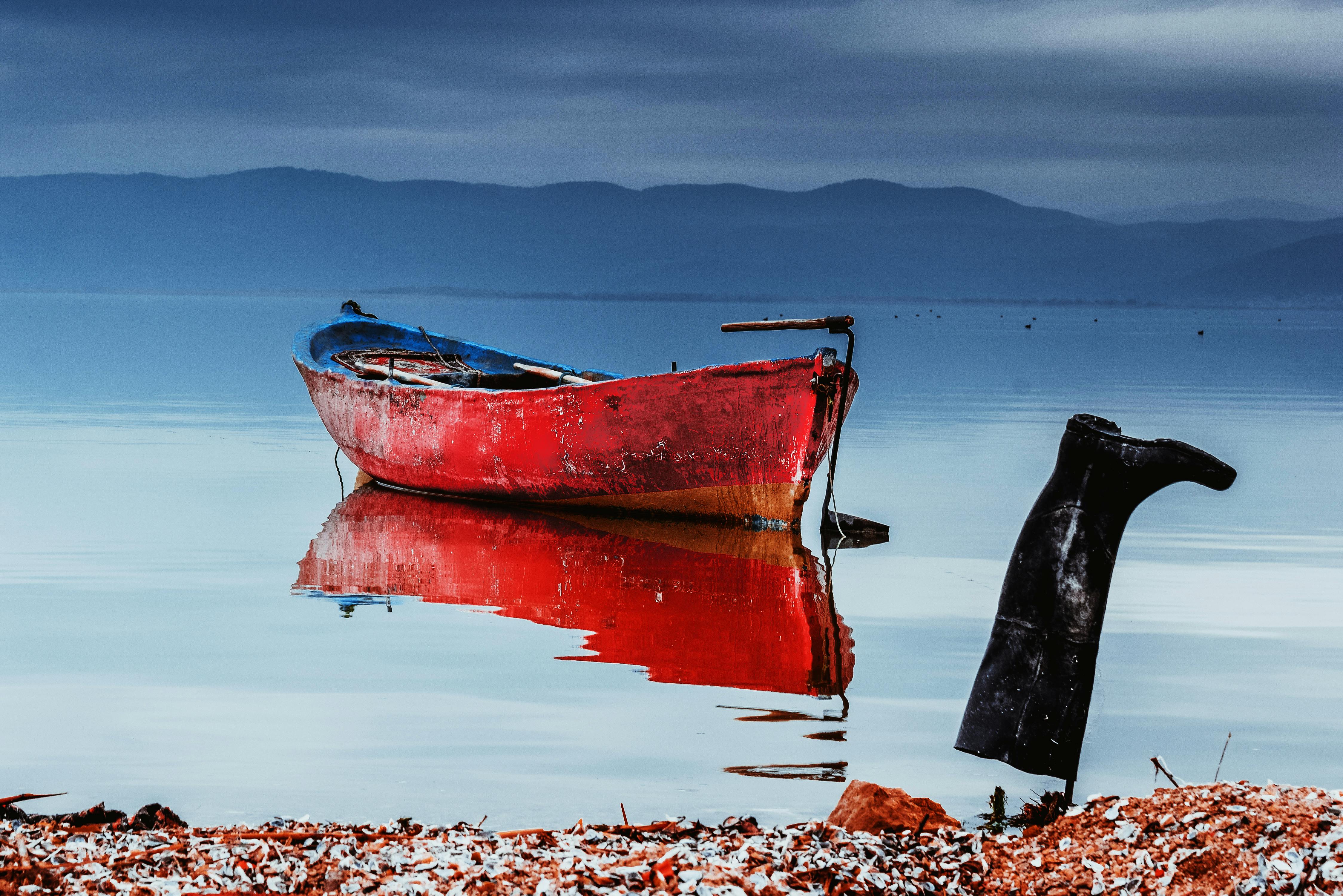 Orange Row Boat on Body of Water · Free Stock Photo