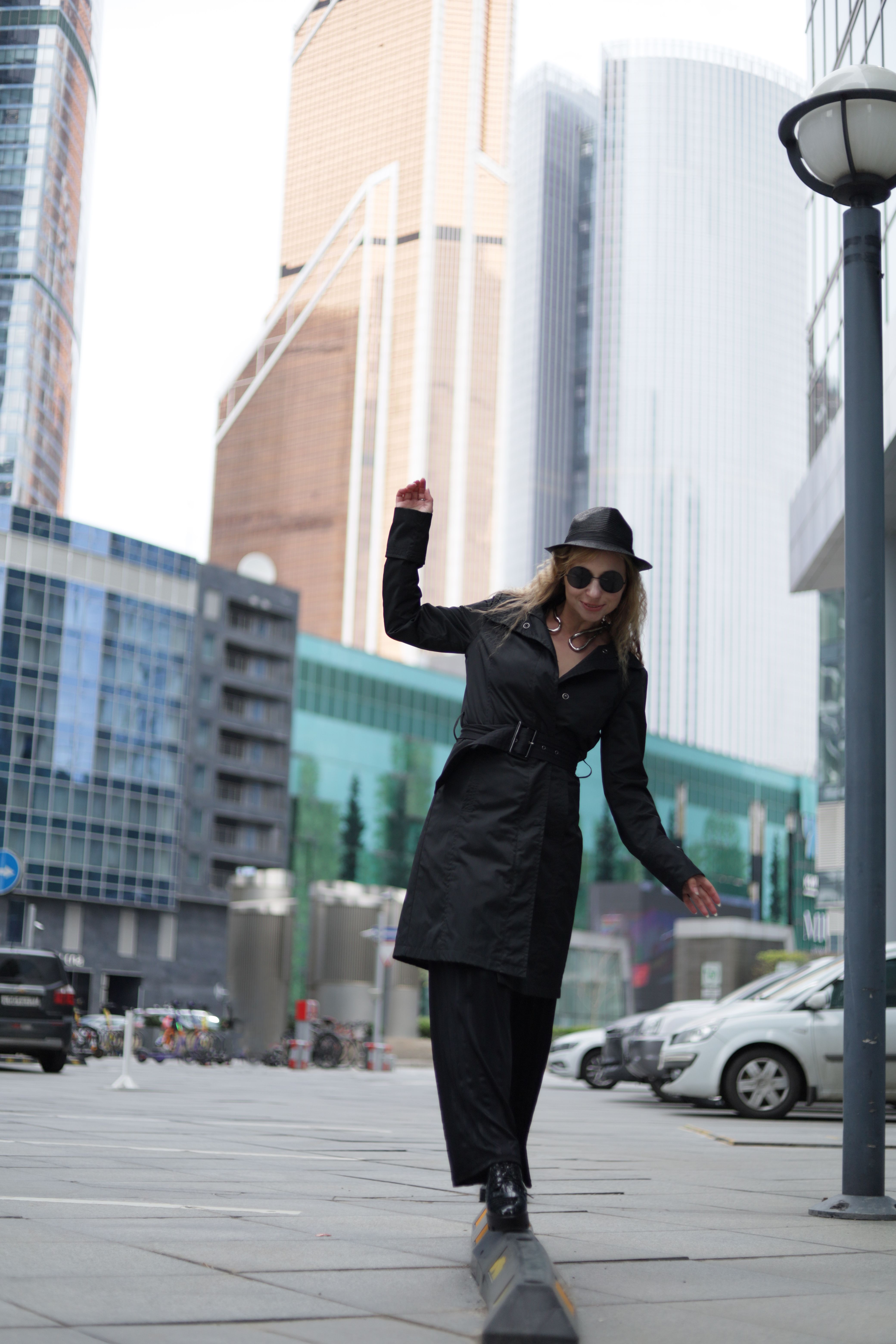 Woman in Black Coat Walking on Curb · Free Stock Photo