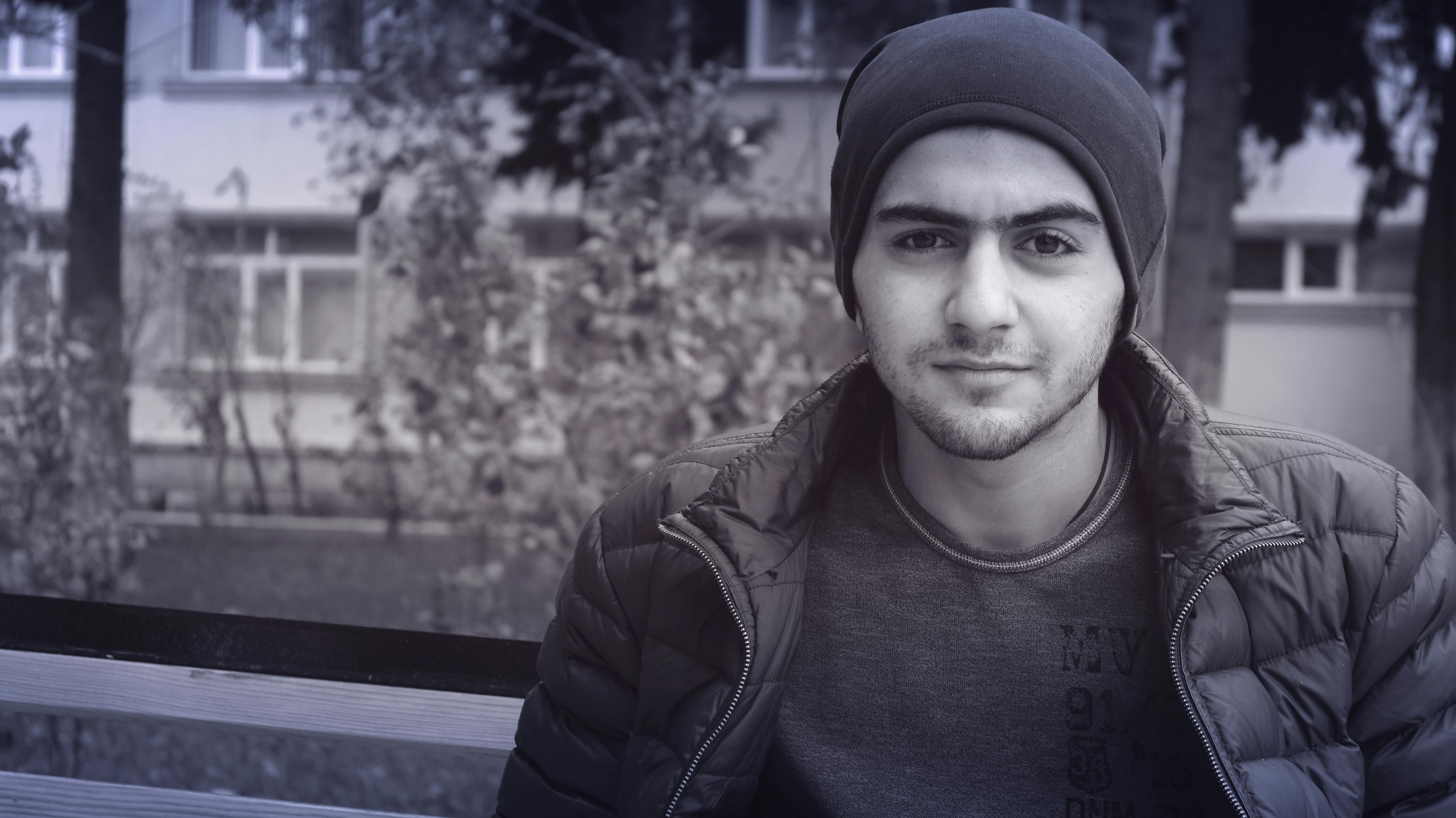 Man in Black Puffer Jacket and Distress Jeans Sitting in Couch · Free ...