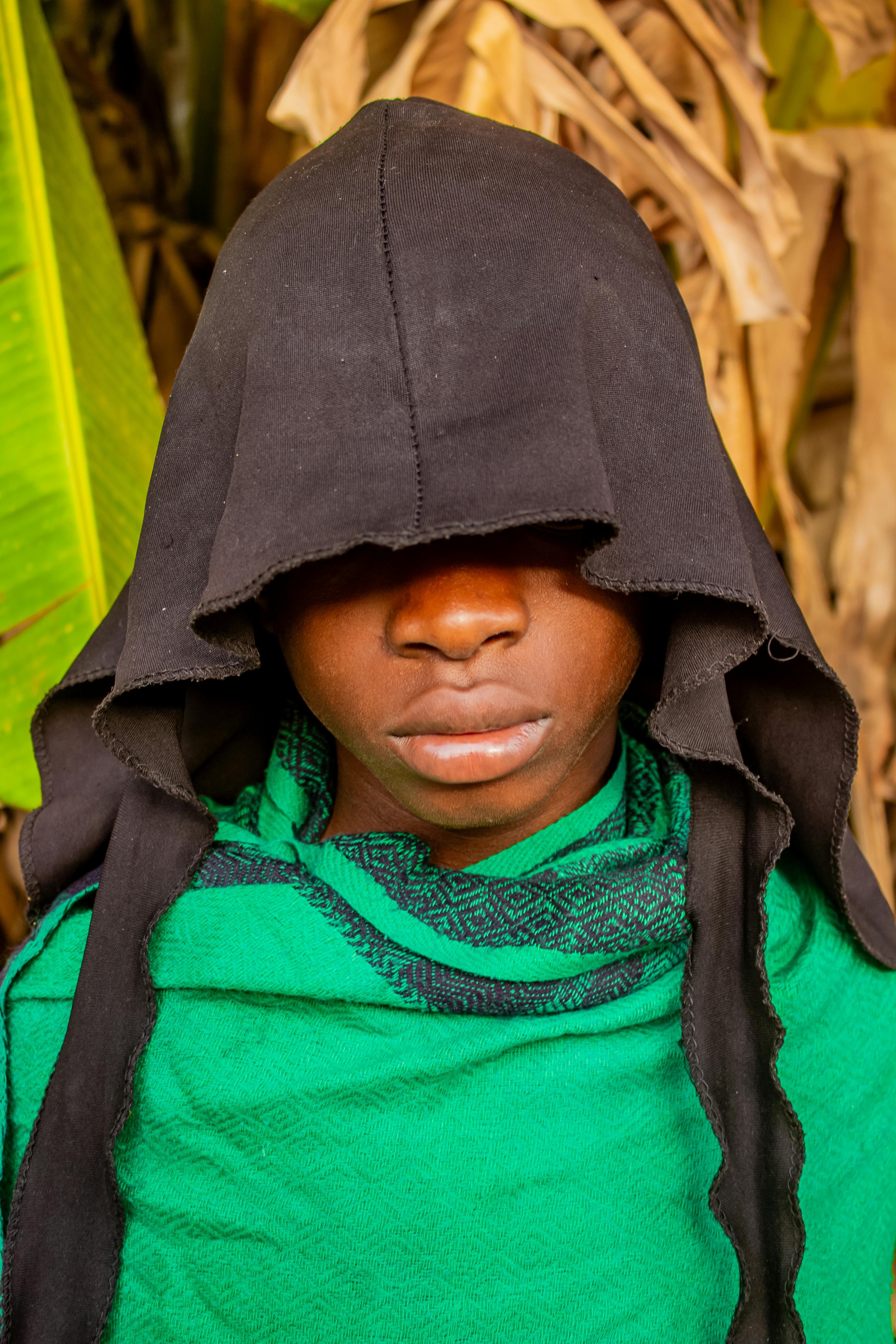 A Boy with a Piece of Cloth Covering his Face · Free Stock Photo
