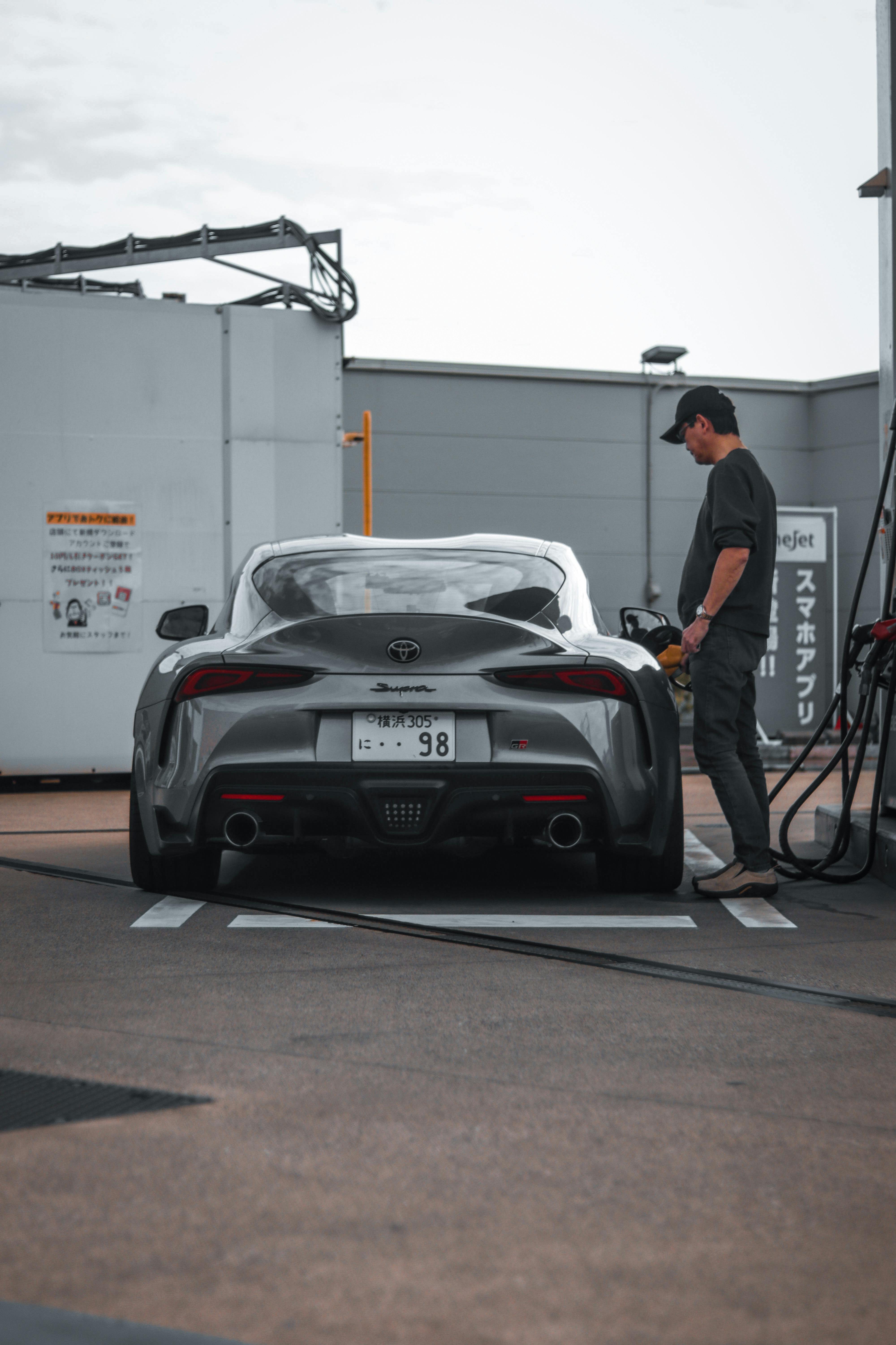 A Man with a Car at a Gas Station · Free Stock Photo
