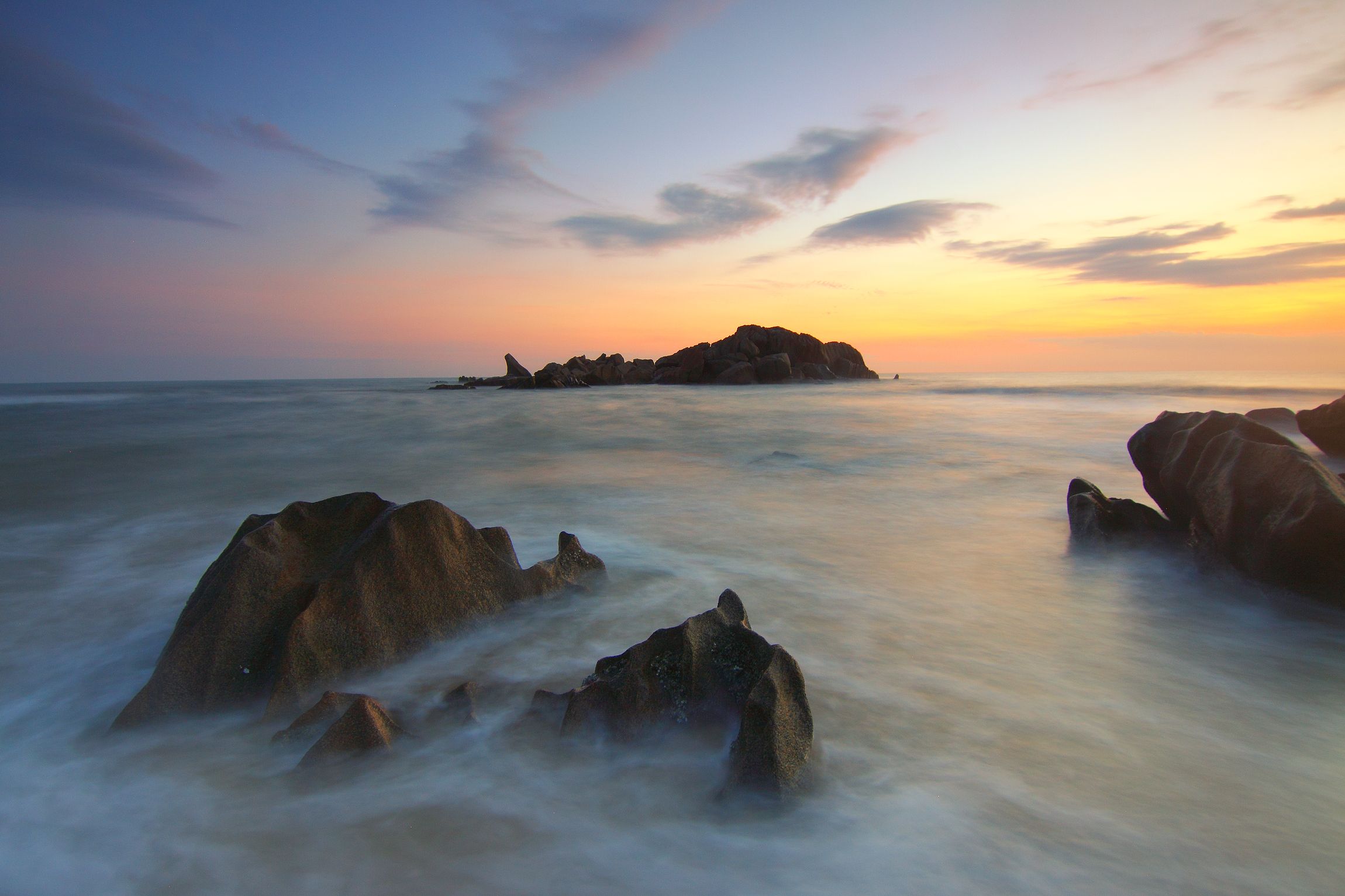 Rock Formation on Body of Water during Golden Hour · Free Stock Photo