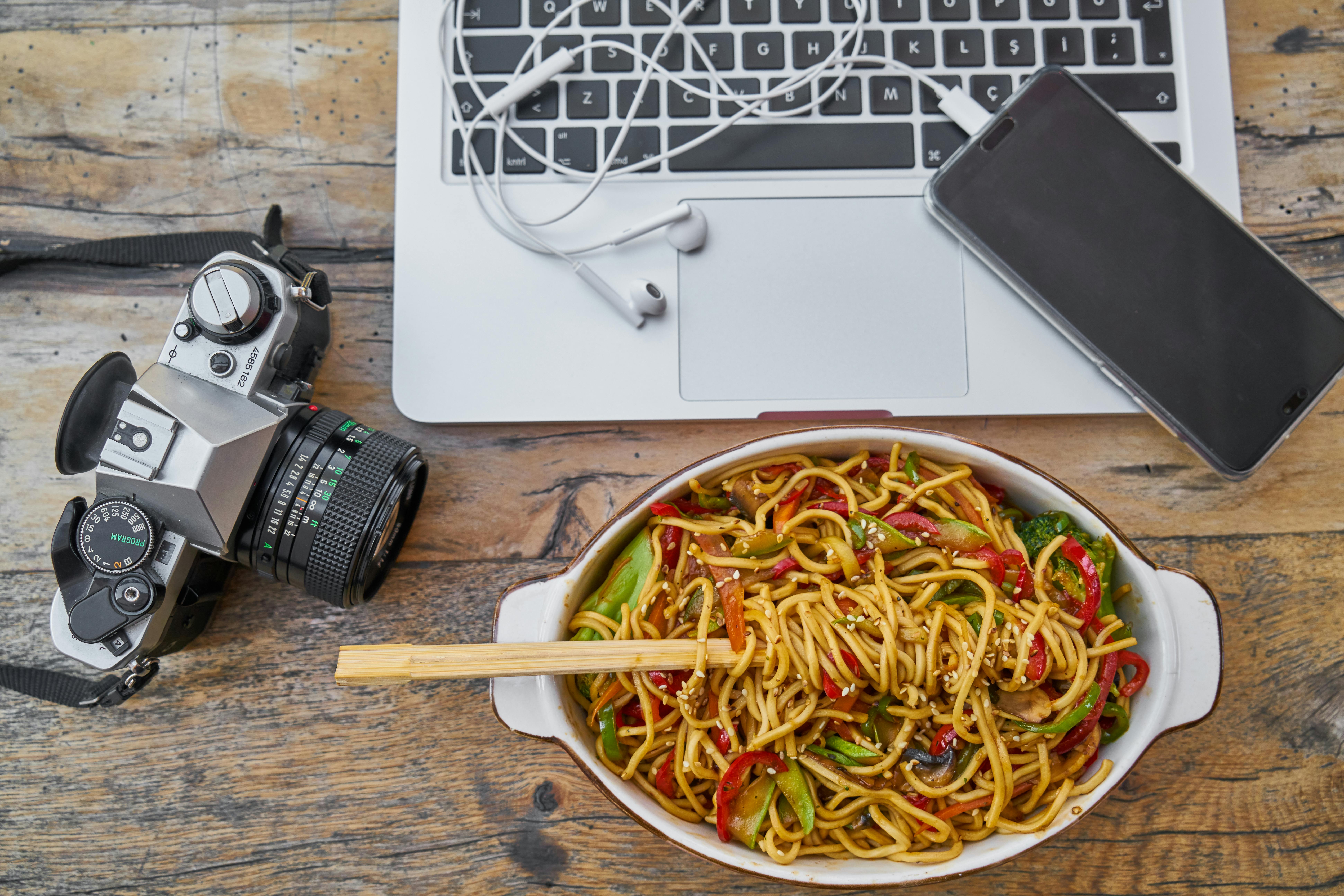 Pasta On Bowl Beside Dslr Camera And Laptop Computer · Free Stock Photo