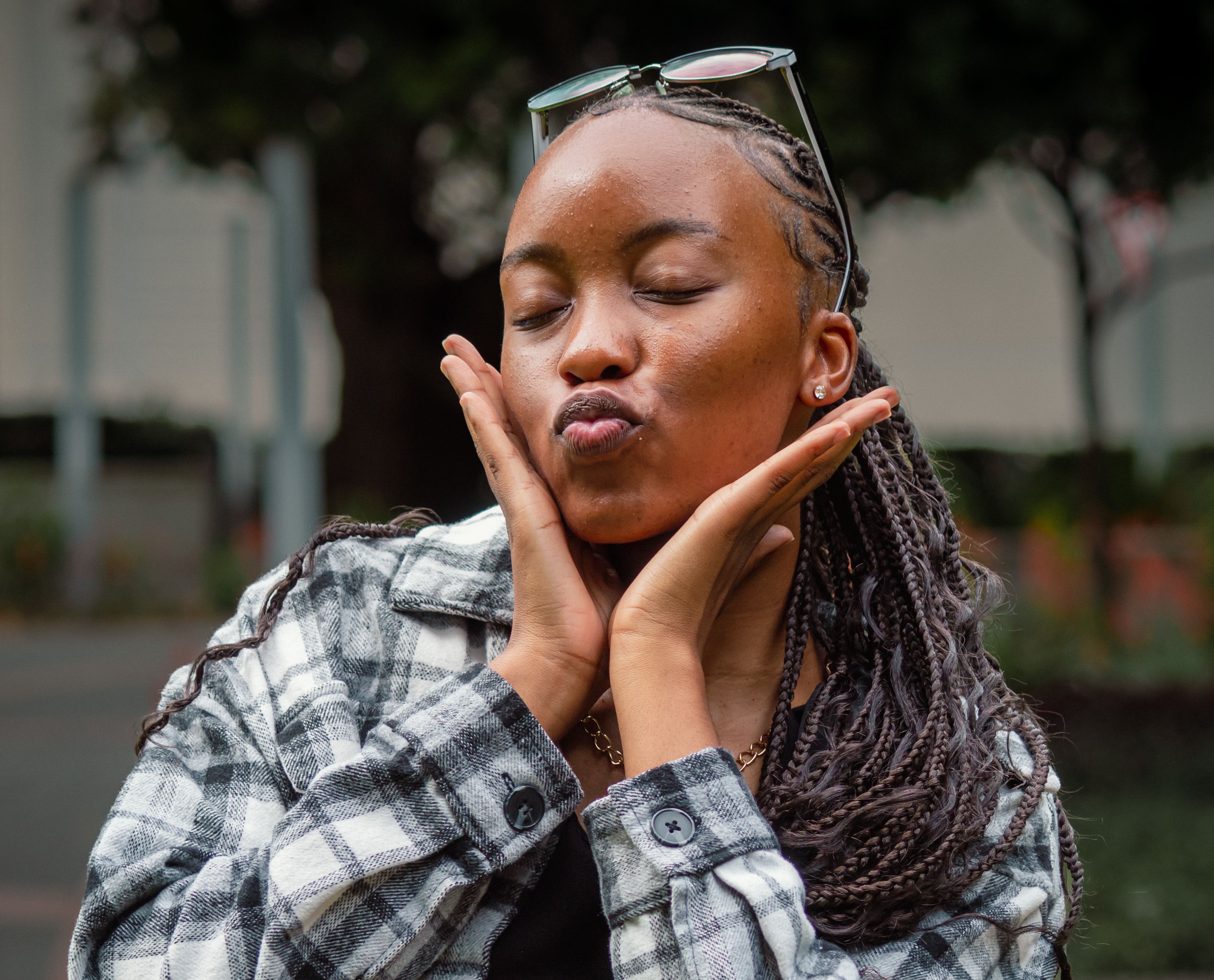 A Young Woman with Braided Hair Making a Kissy Face · Free Stock Photo