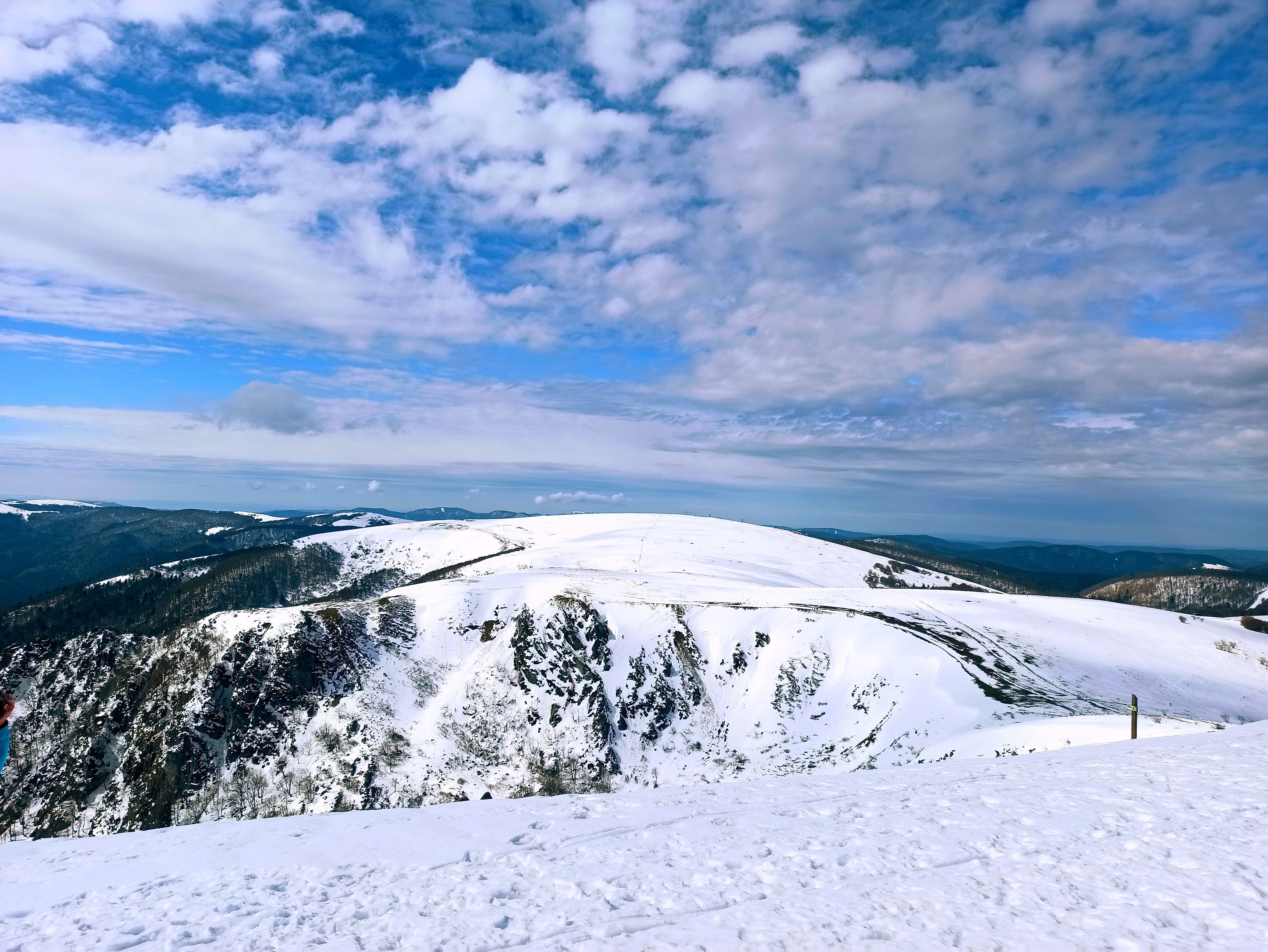 A view of a snowy mountain with a blue sky · Free Stock Photo