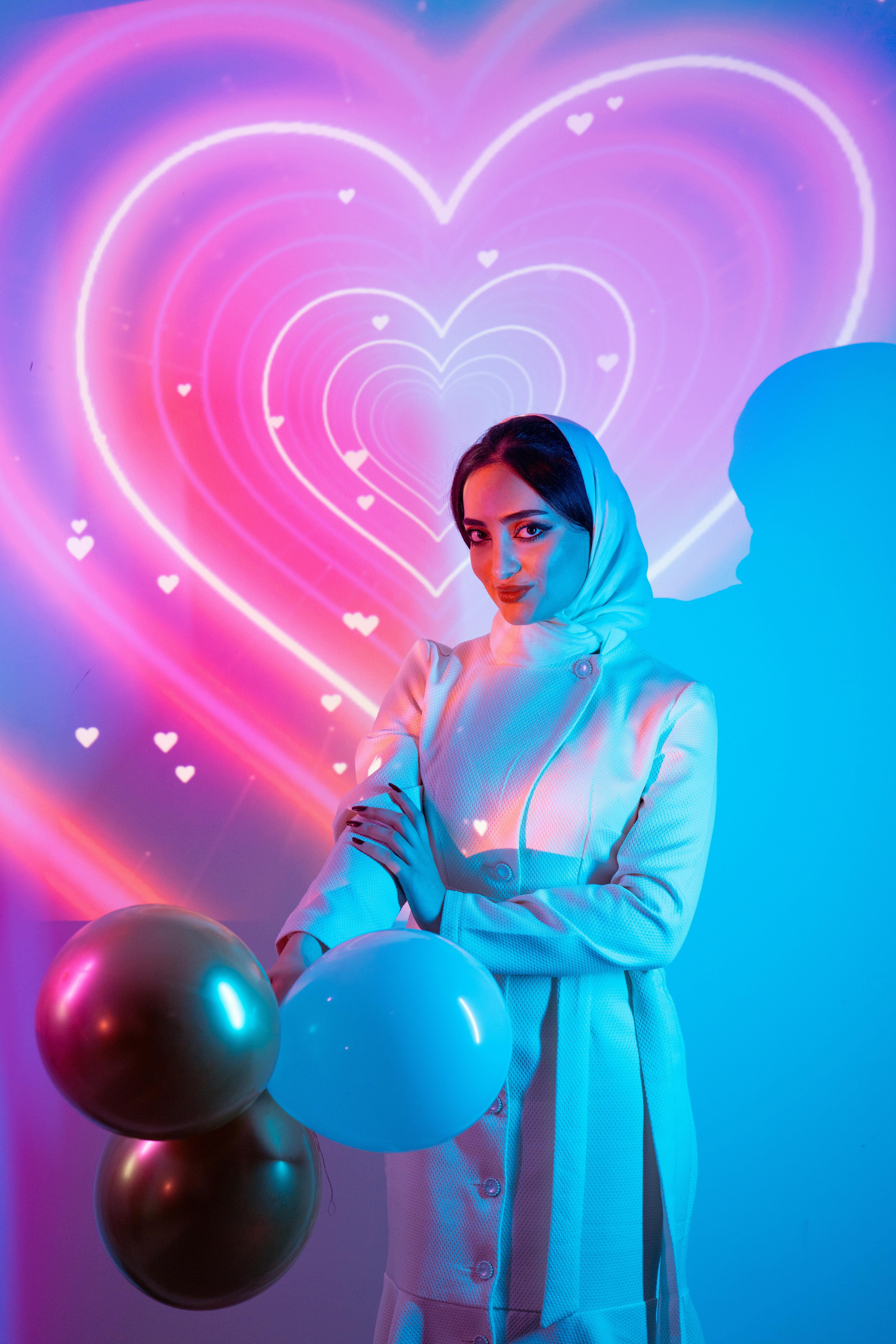 Studio Shot of a Young Woman Illuminated by a Heart Shape Projection ...