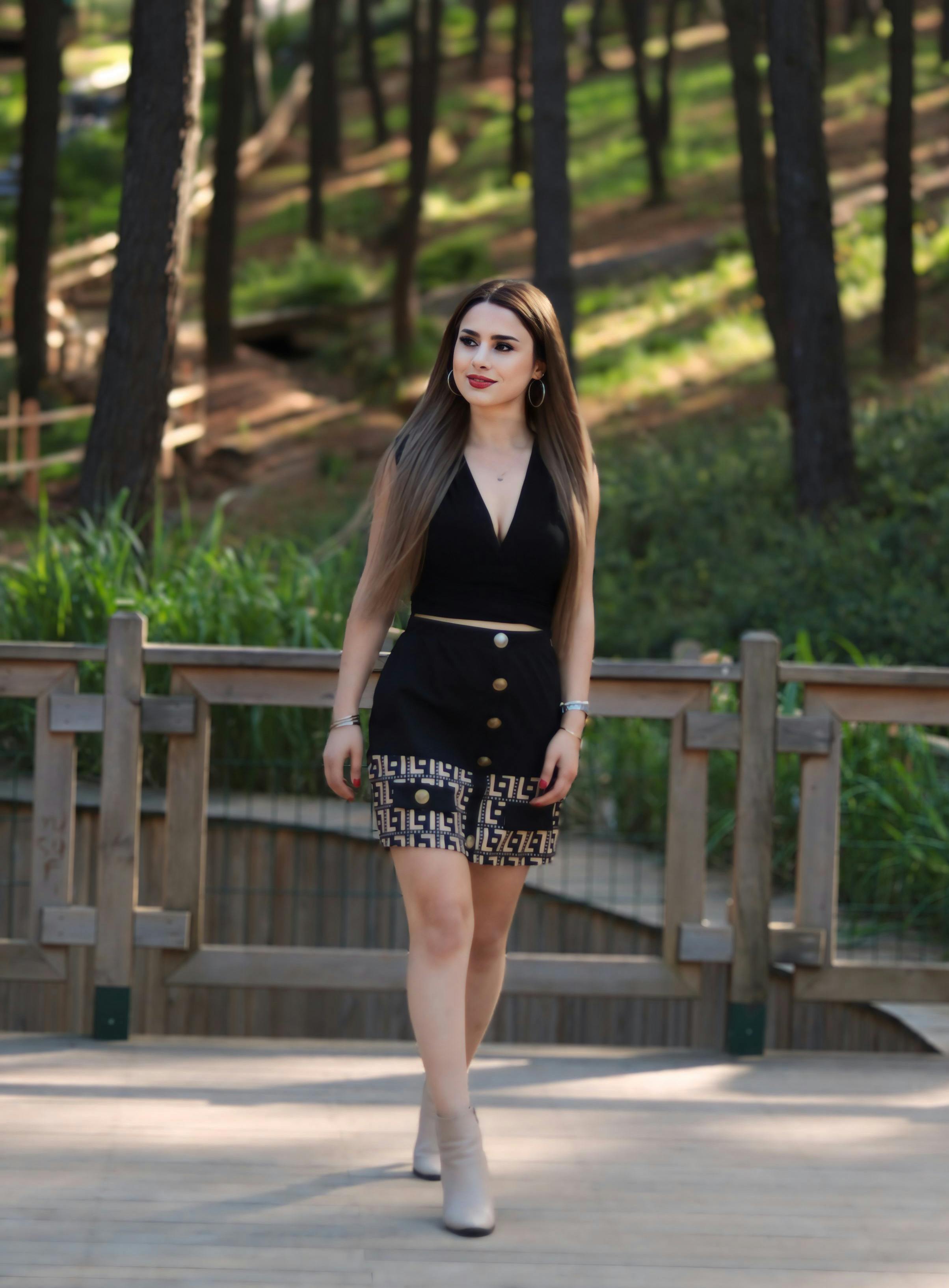 A Young, Fashionable Woman Posing in a Park · Free Stock Photo