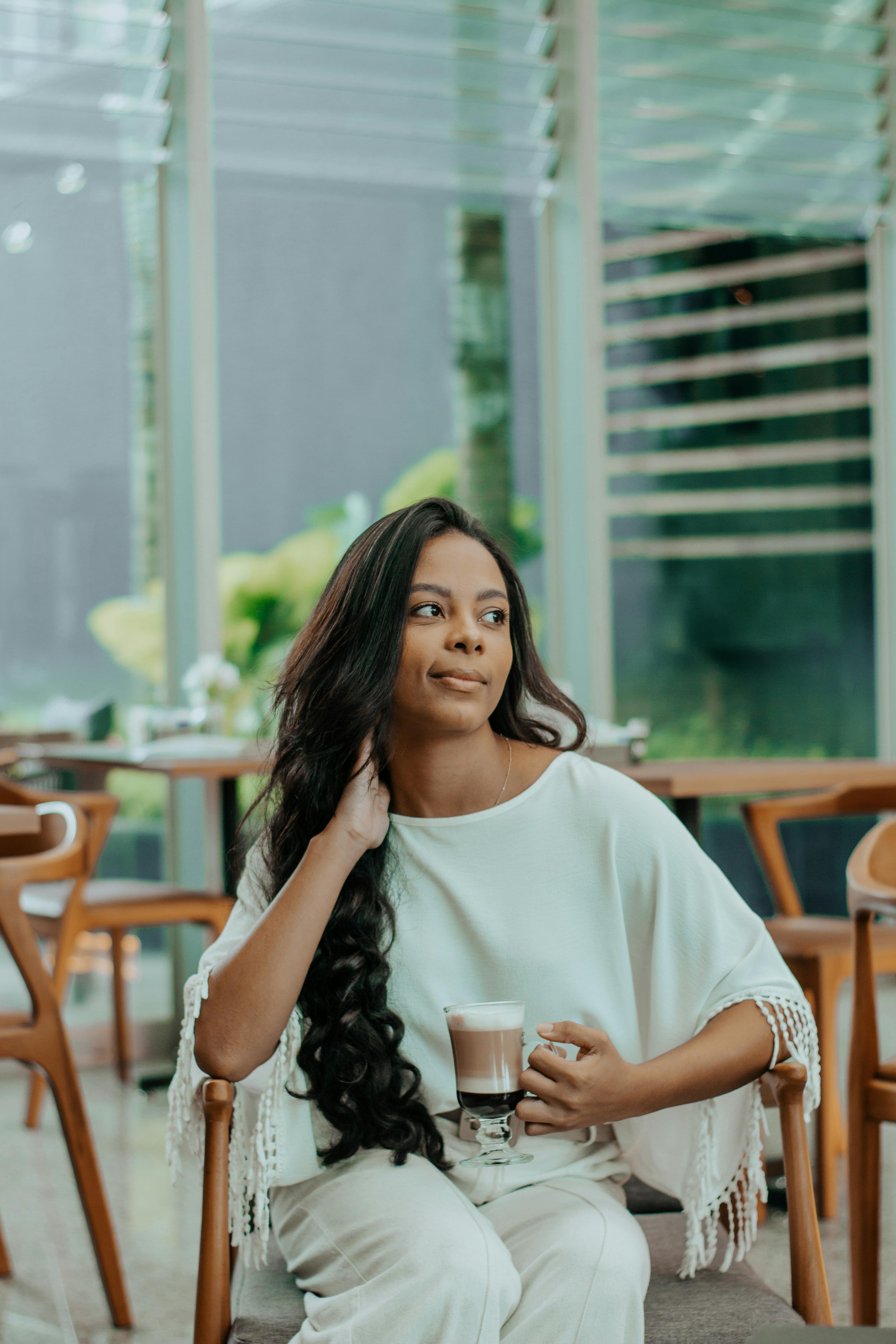Woman Sitting with Coffee at Cafe · Free Stock Photo