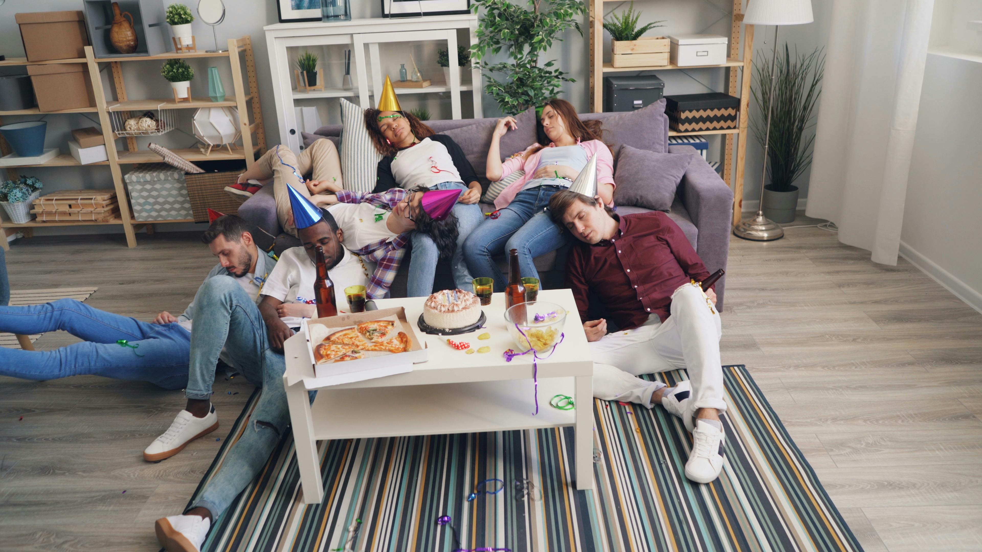 A group of people sitting on a couch in a living room · Free Stock Photo
