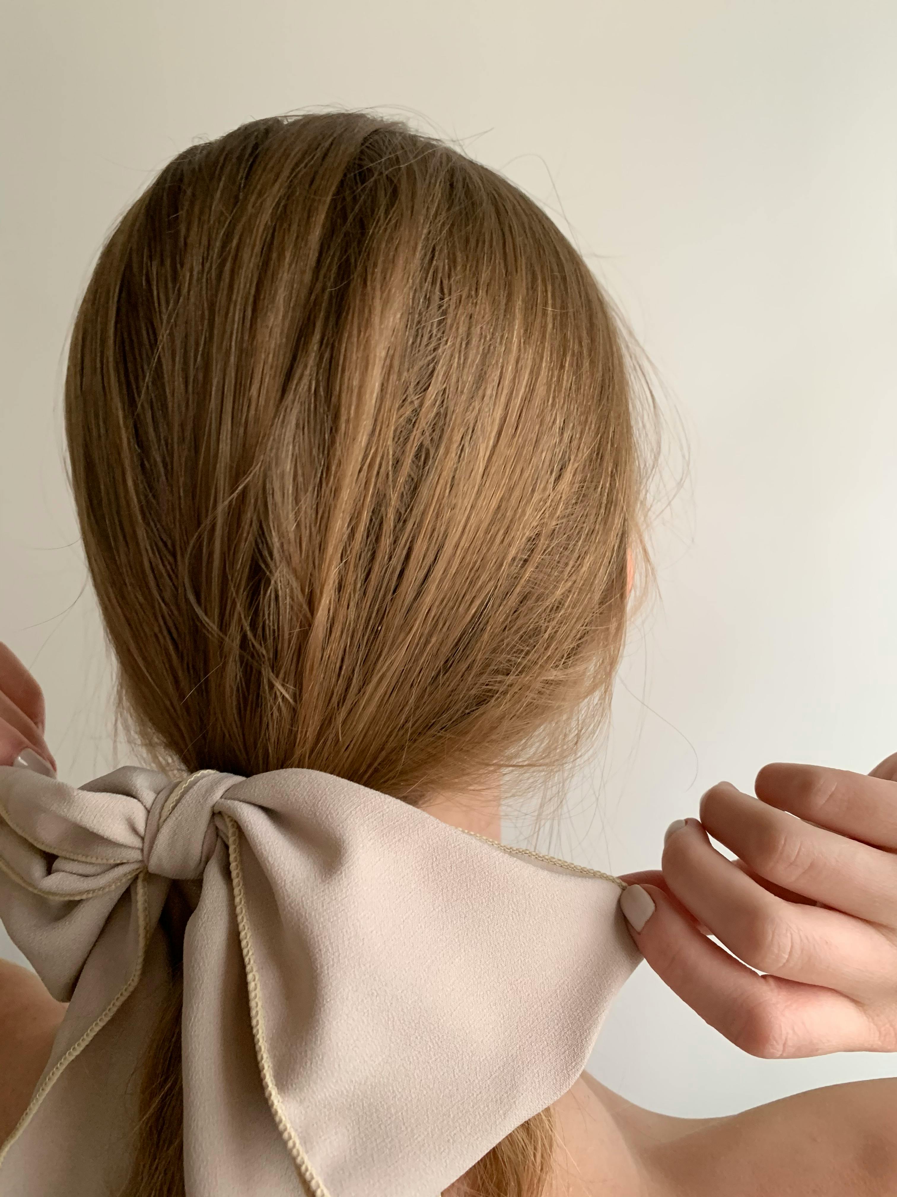 Woman Fixing Ribbon in her Hair · Free Stock Photo