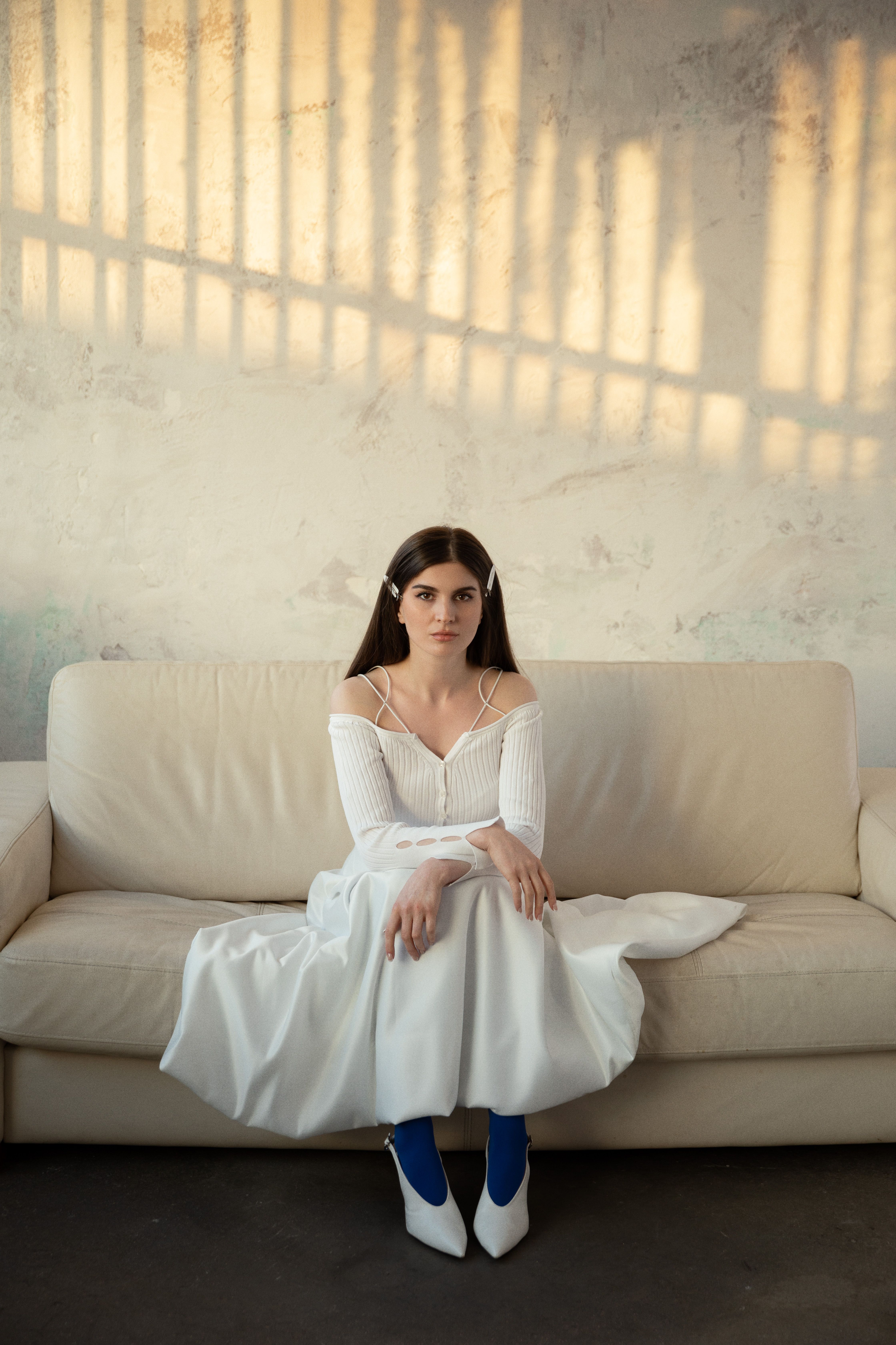 Woman in Dress Sitting on Sofa · Free Stock Photo