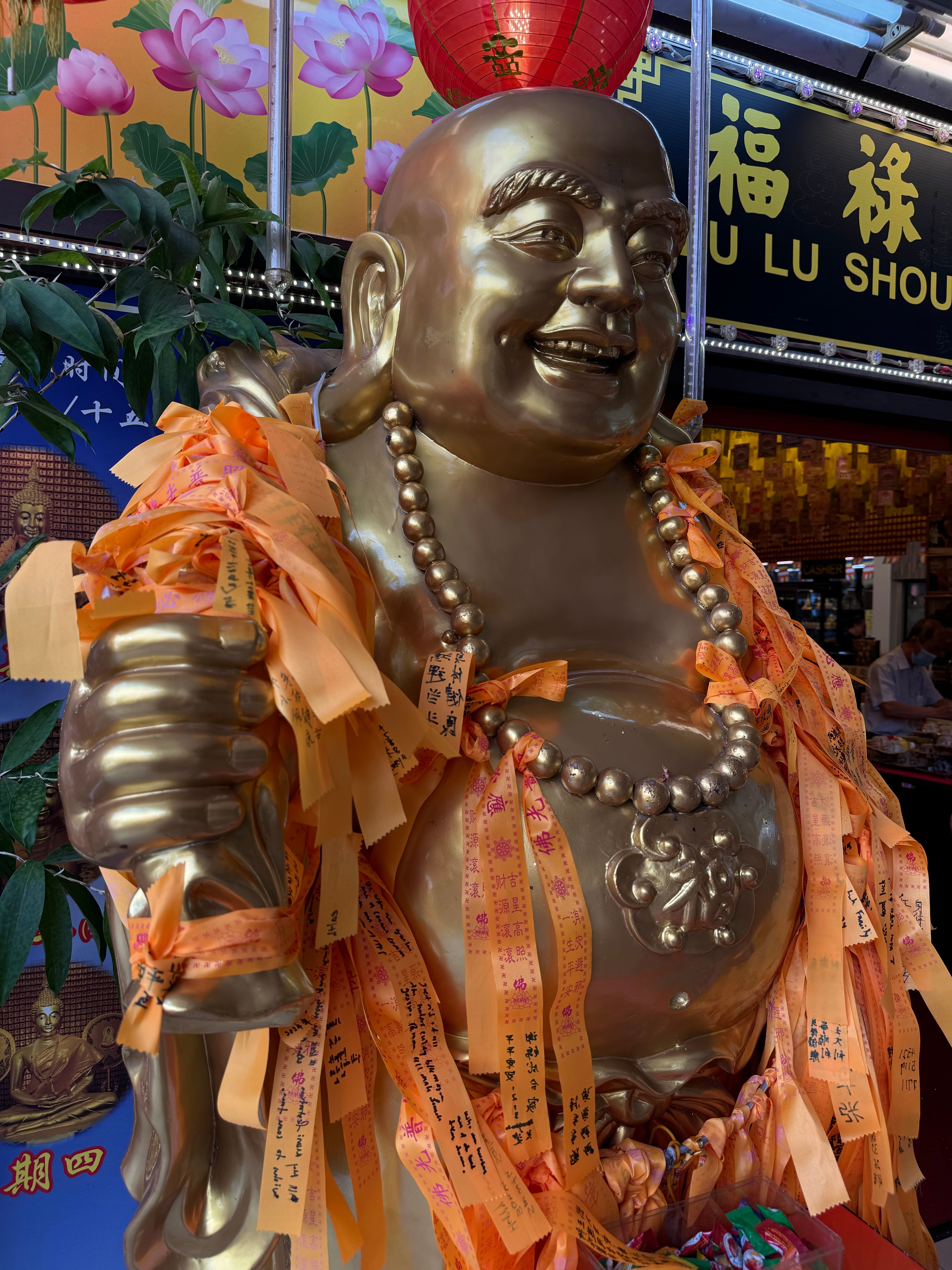 A buddha statue with orange ribbon and a gold base · Free Stock Photo