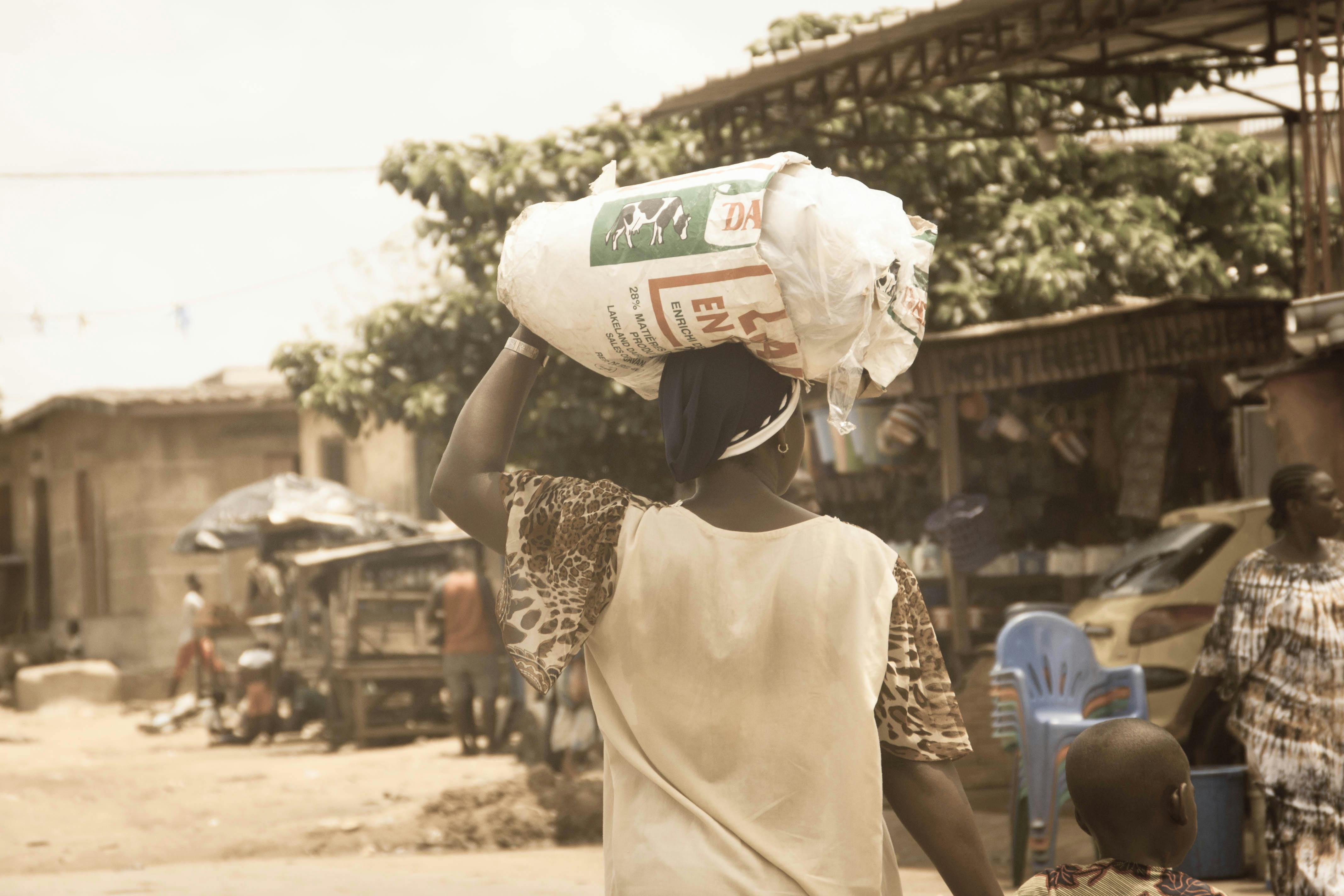Woman Carrying Sack · Free Stock Photo