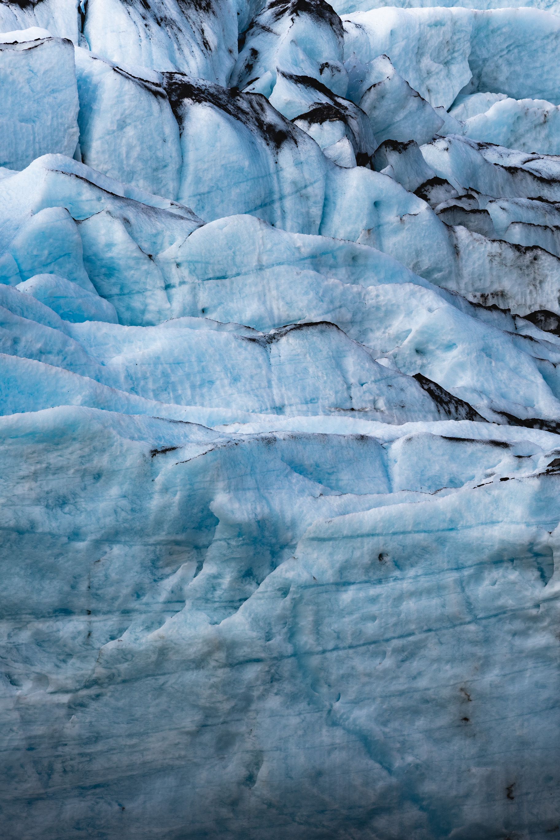 A glacier is covered in blue ice · Free Stock Photo