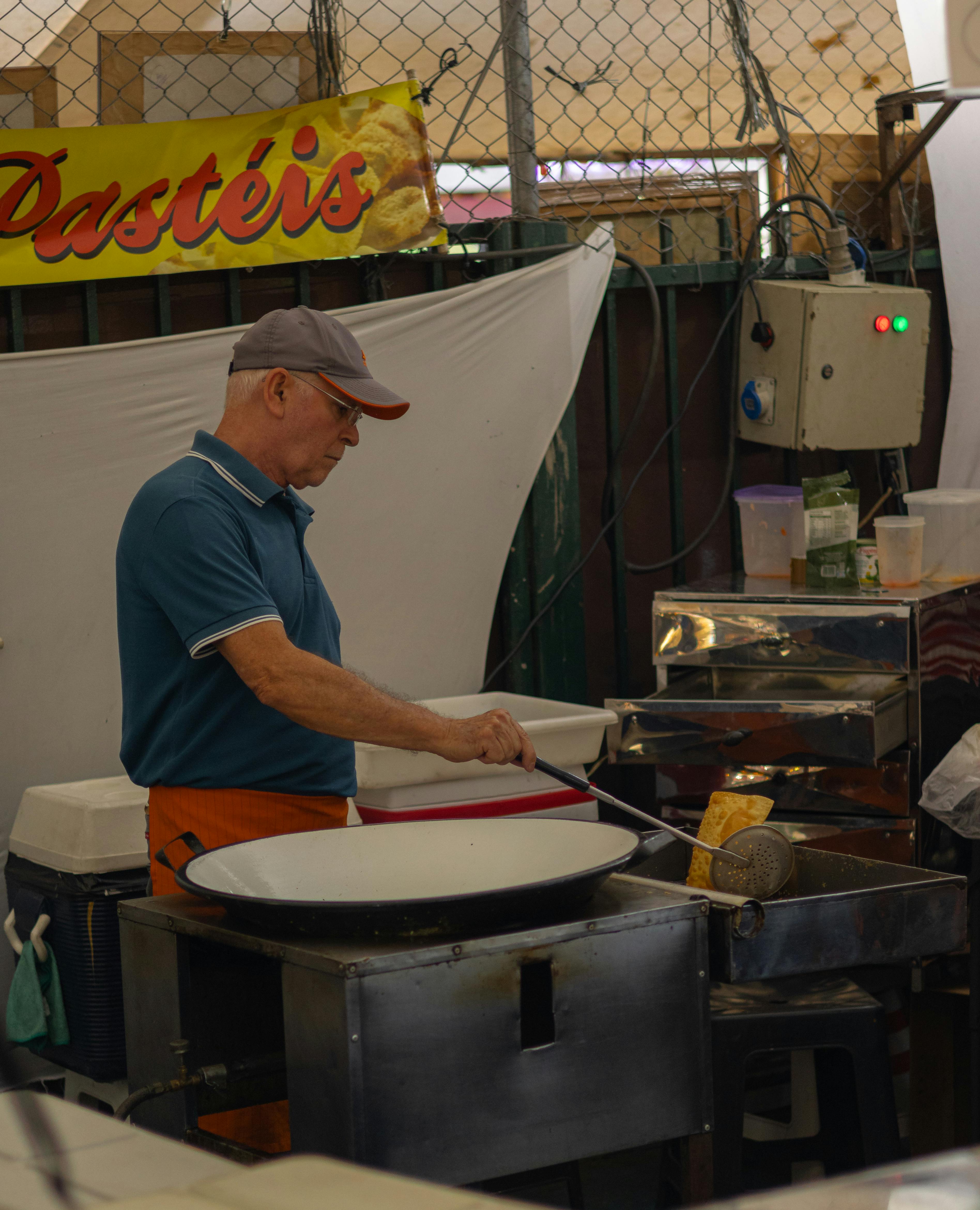 Senior Man Working at a Concession Stand · Free Stock Photo