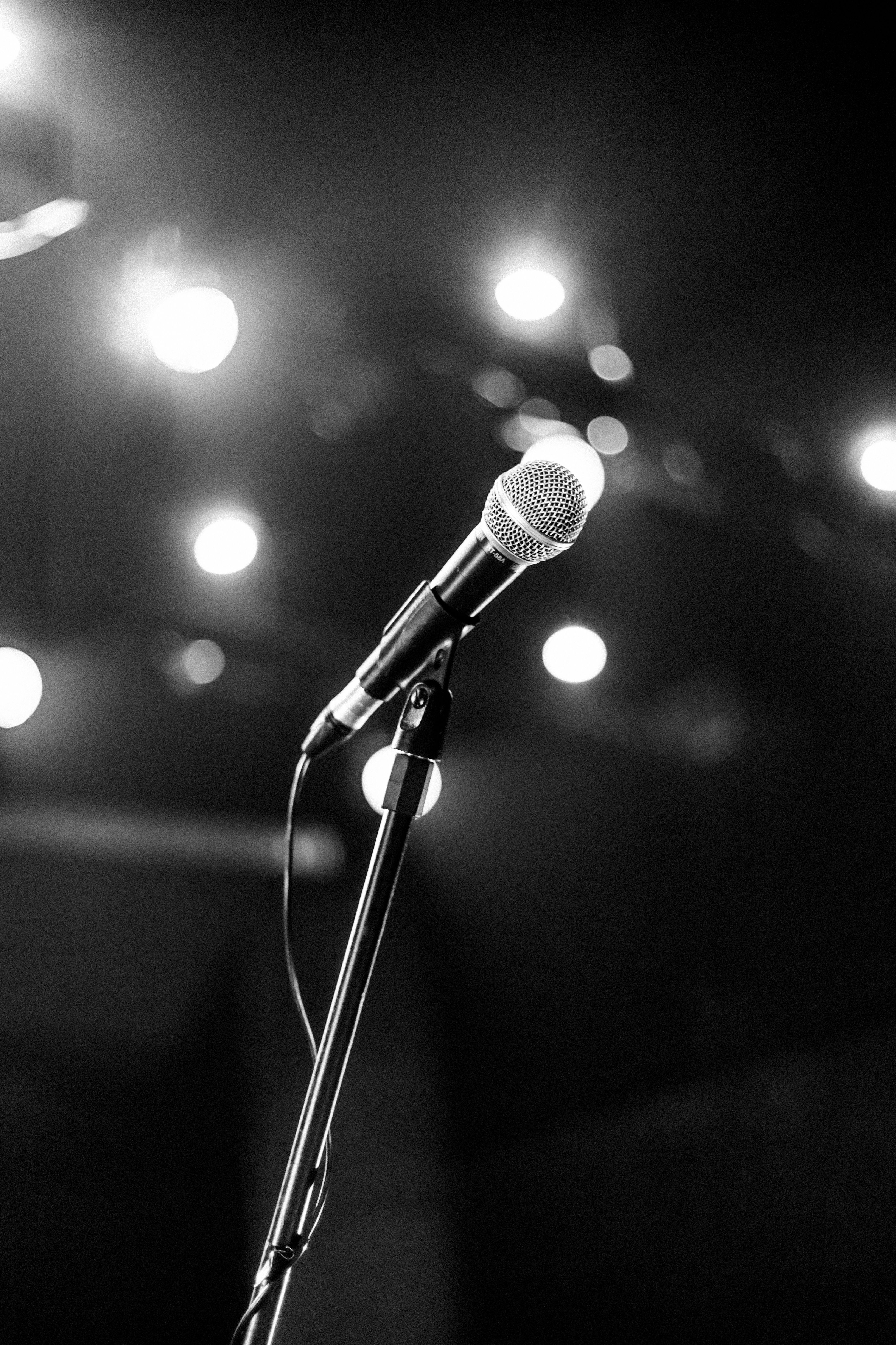 Black and White Photograph of a Microphone on a Stage, and Spotlight ...