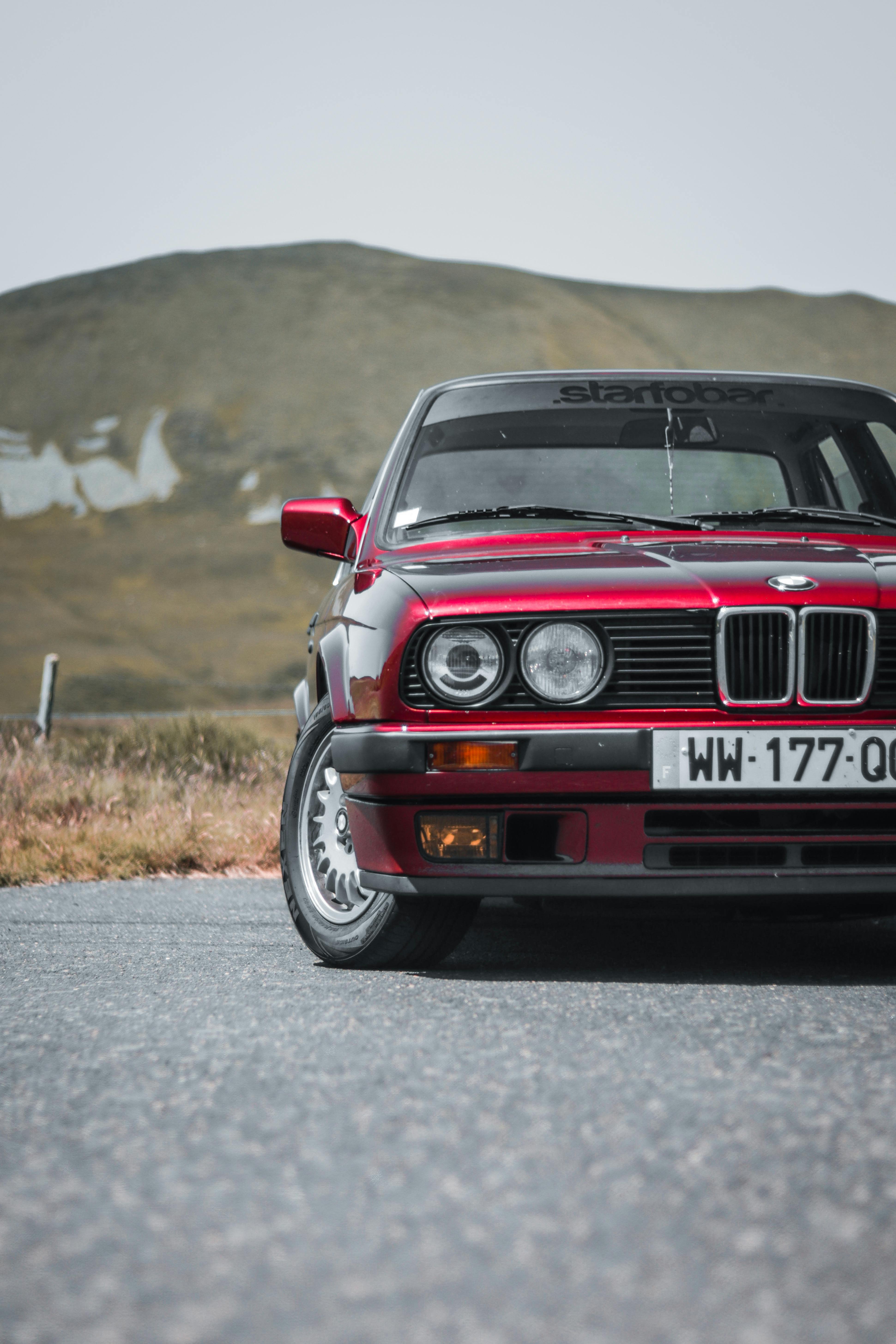 Red BMW 325i Car on Parking Lot in Mountains · Free Stock Photo