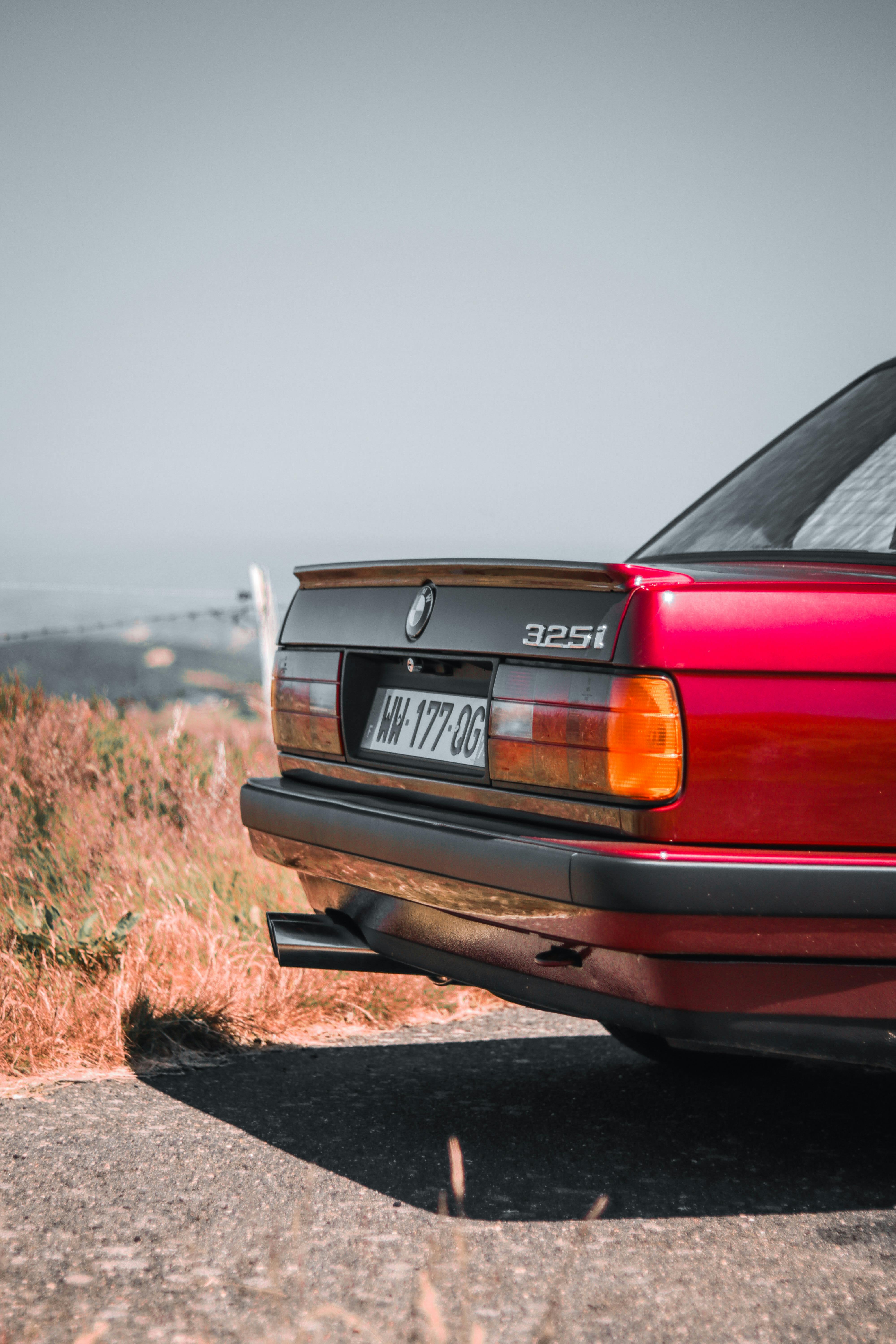 Red BMW 325i Parked on Roadside · Free Stock Photo