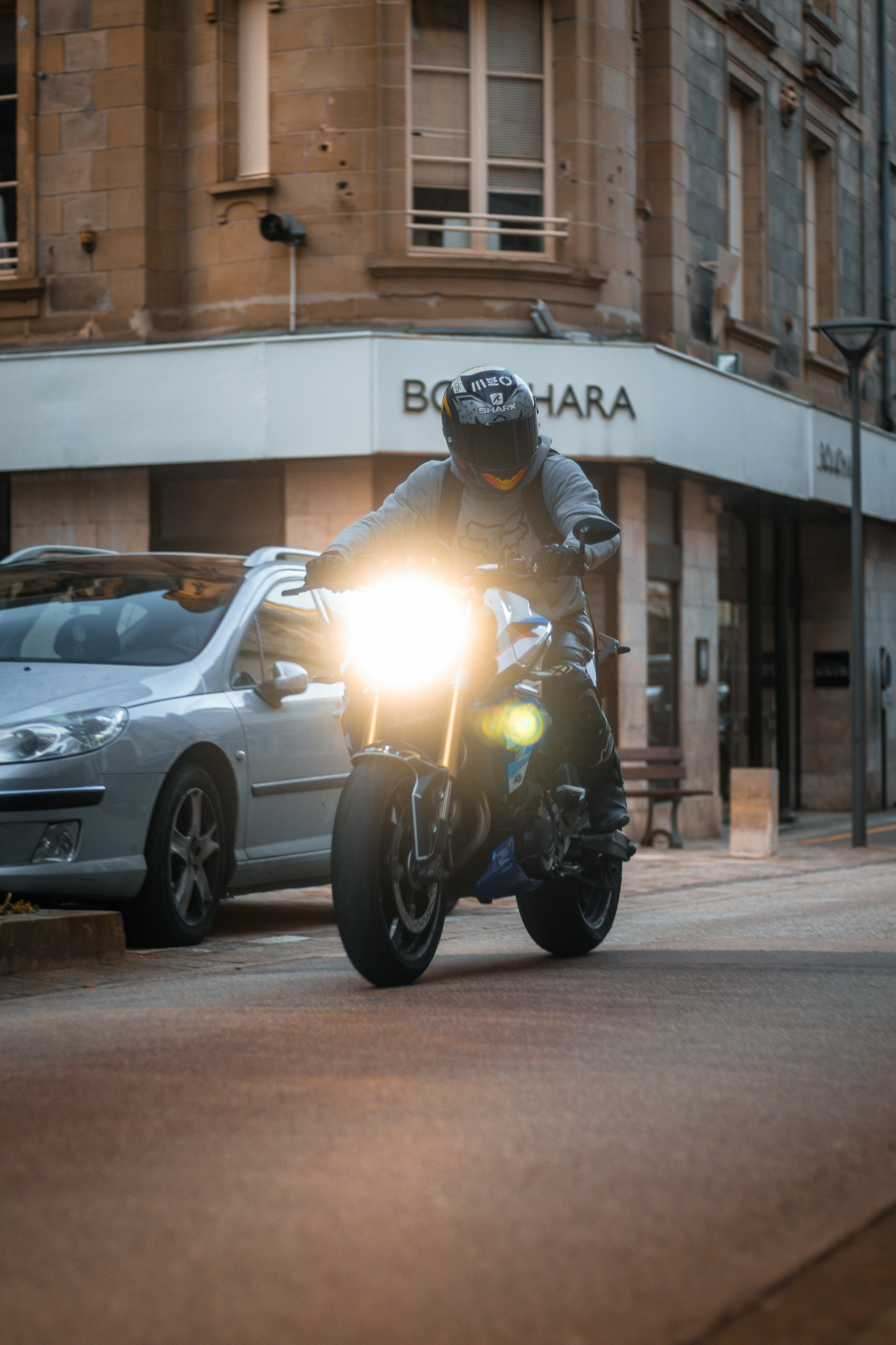 Man on Motorcycle Riding with Headlight on · Free Stock Photo