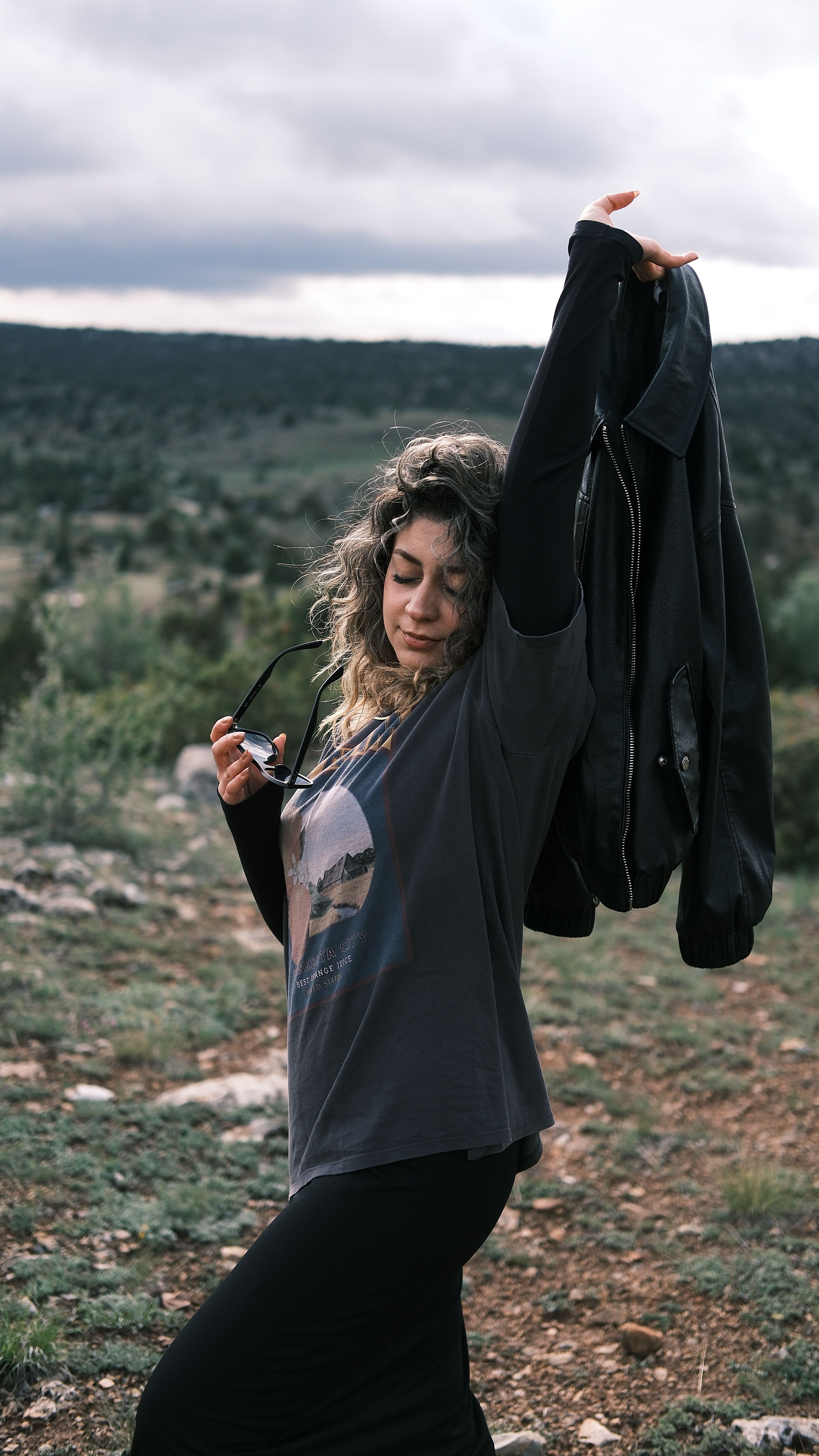 Woman Holding Jacket in Raised Arm · Free Stock Photo