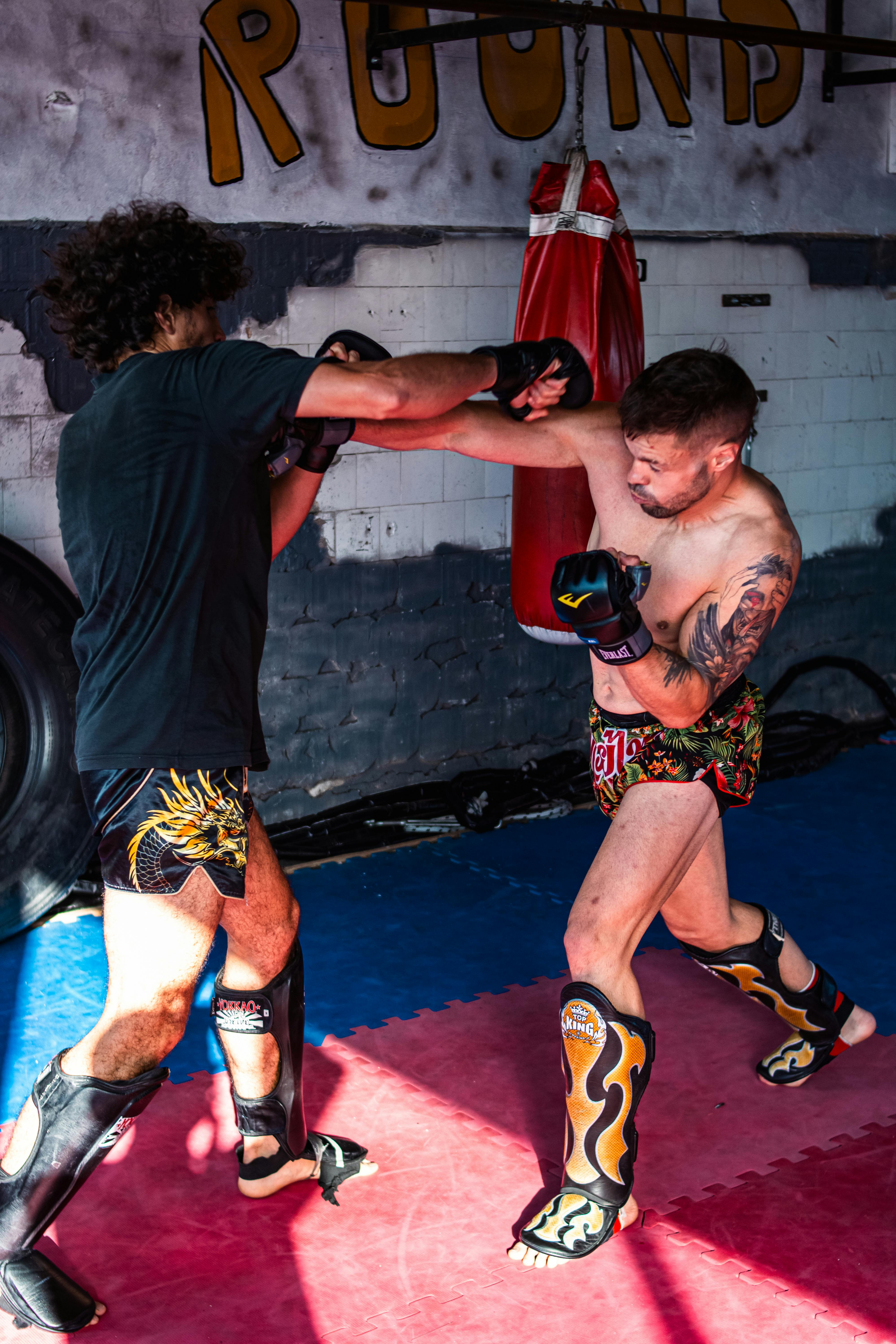 Two Men Sparring in a Gym · Free Stock Photo