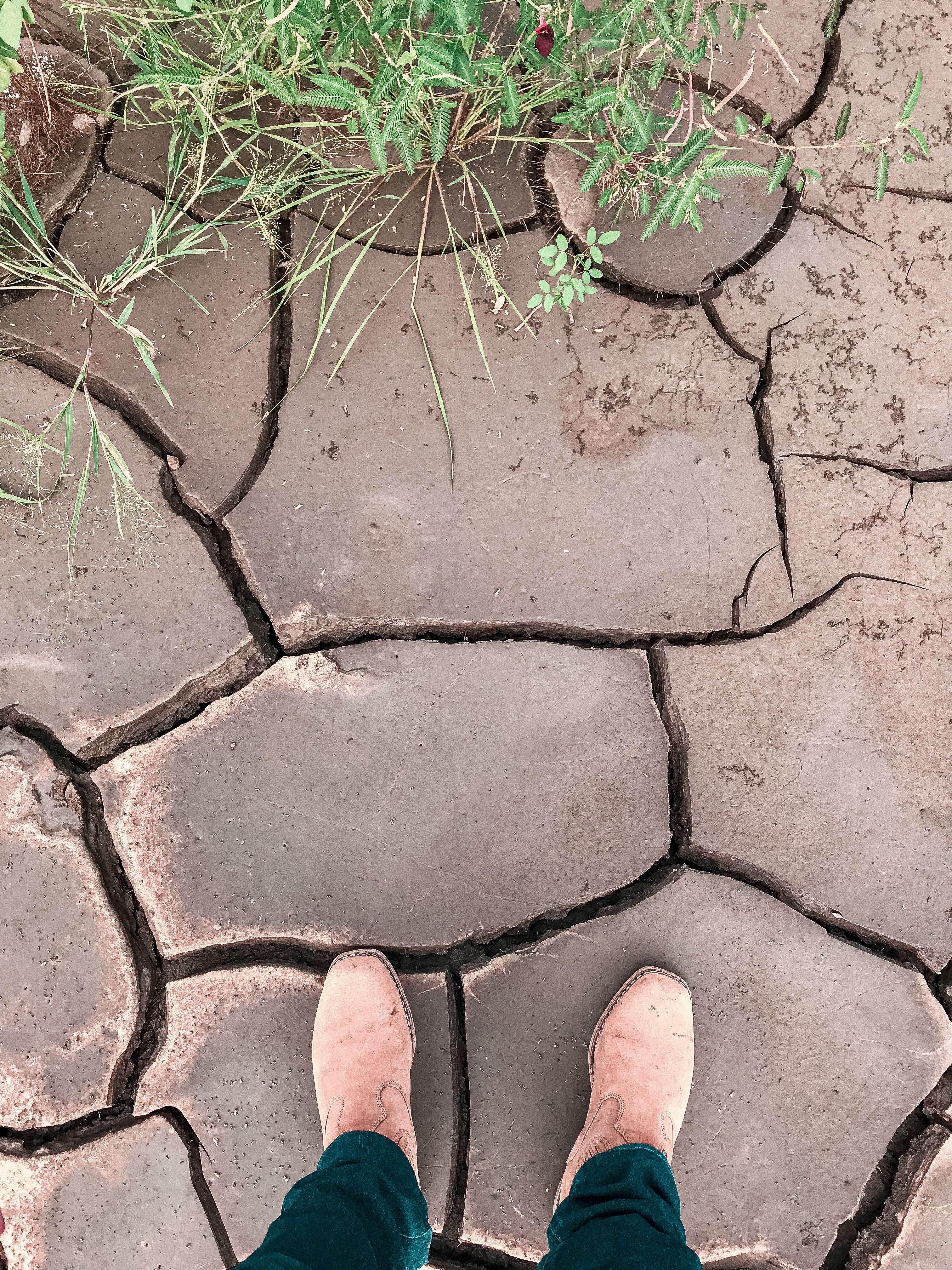 Woman Standing on Rocky Pavement vertical shot · Free Stock Photo