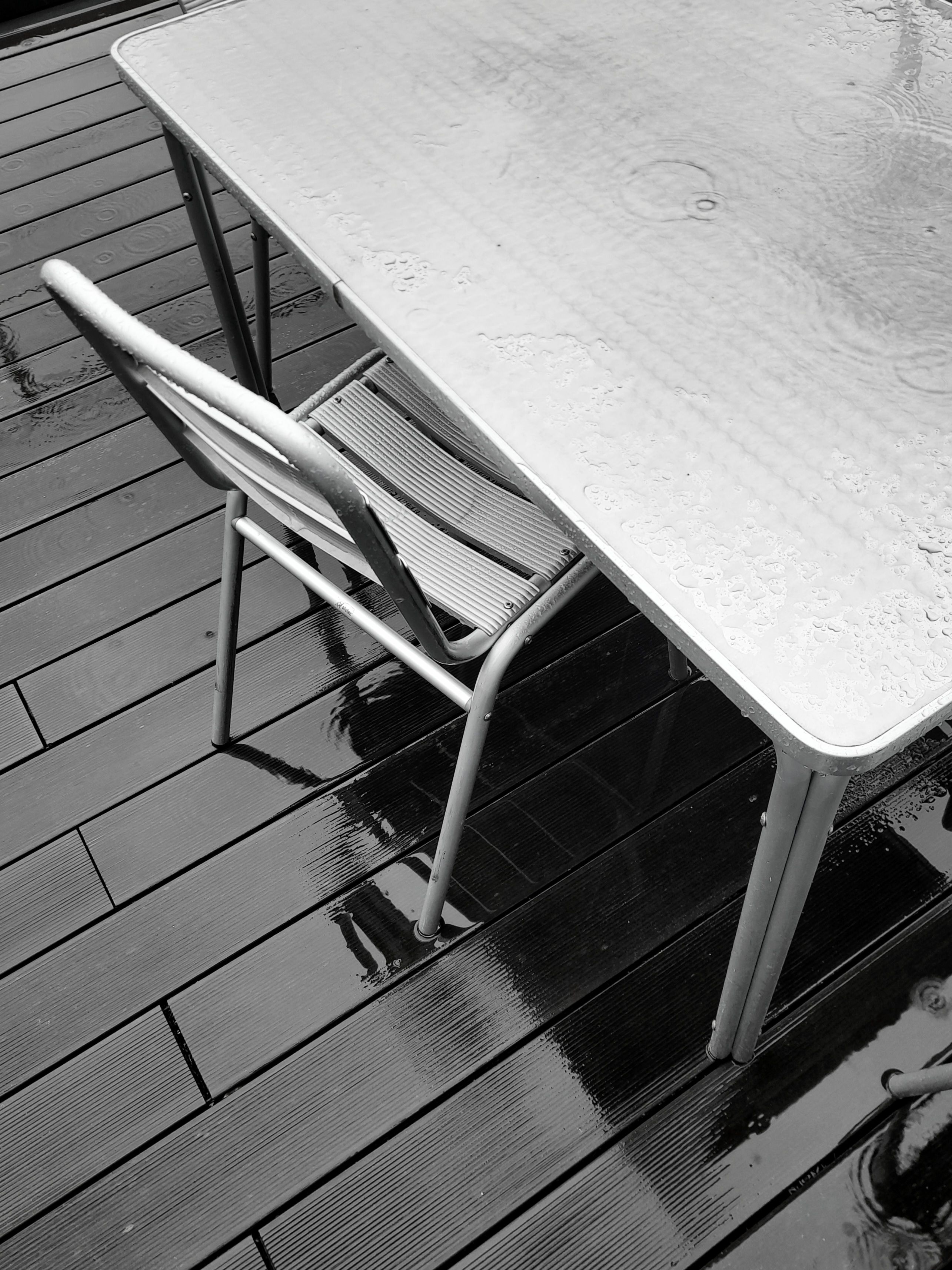 Wet Table and Chair in Black and White · Free Stock Photo