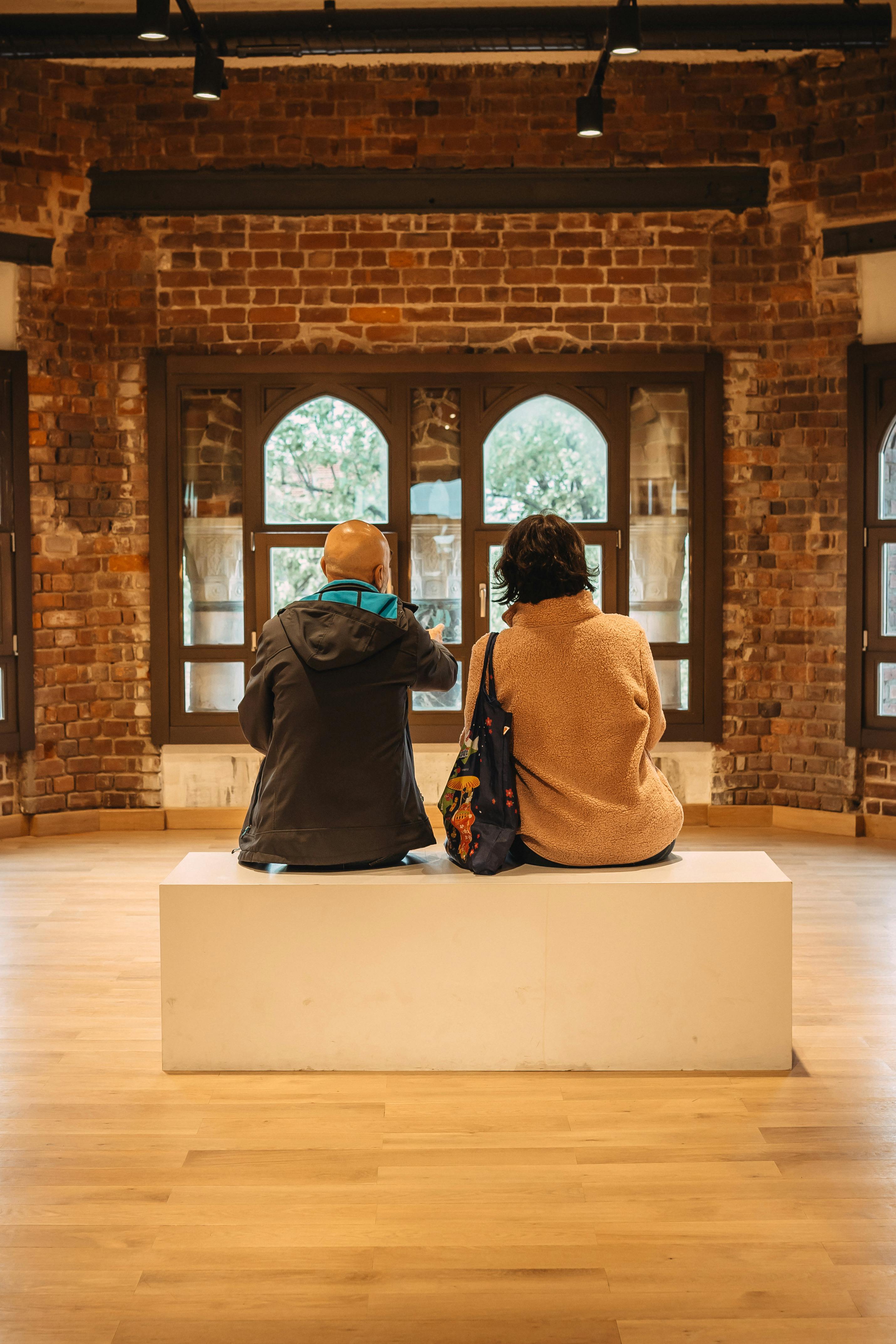 Elderly Couple in a Brick Building · Free Stock Photo