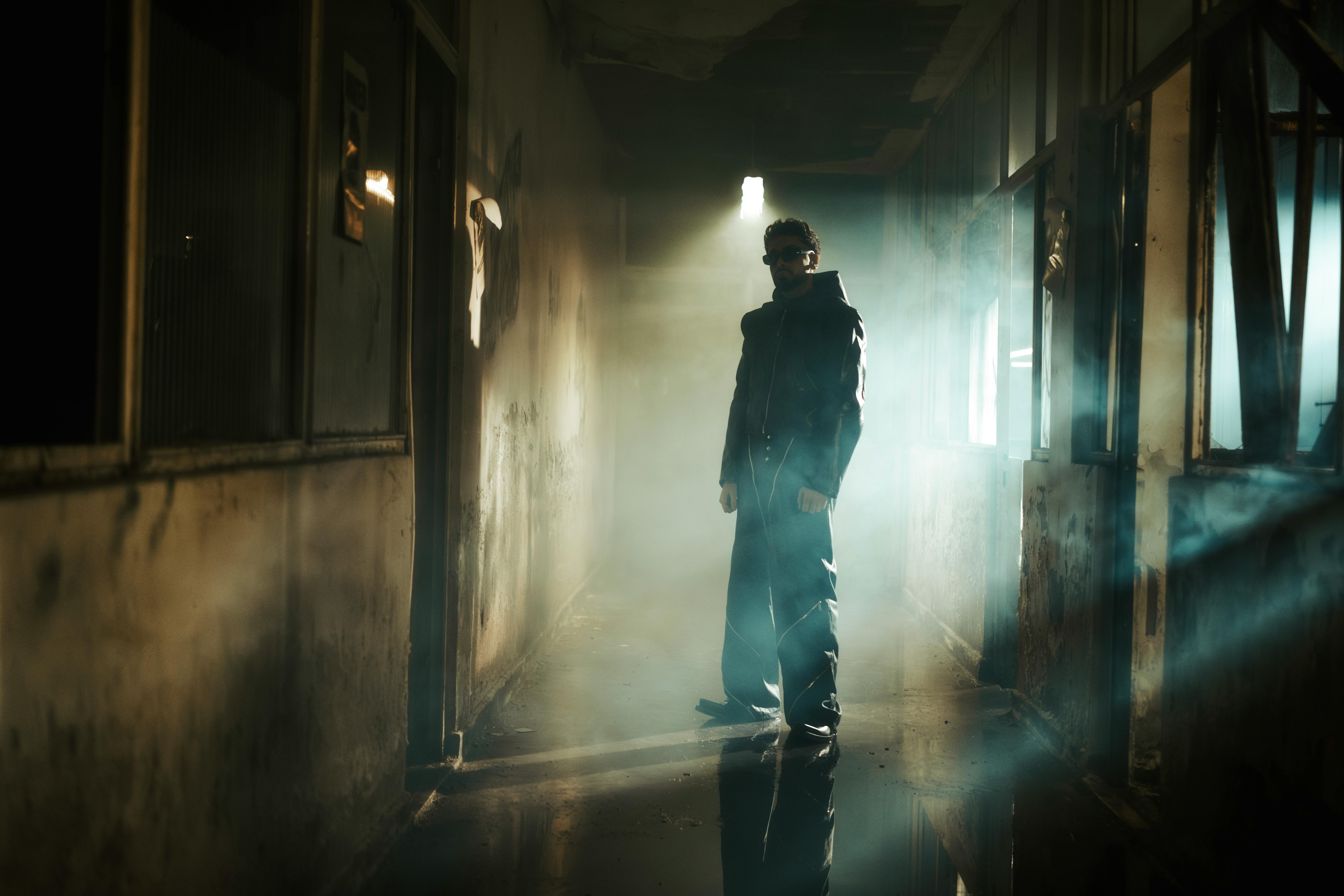 Person Standing in a Hallway in a Dark Room · Free Stock Photo