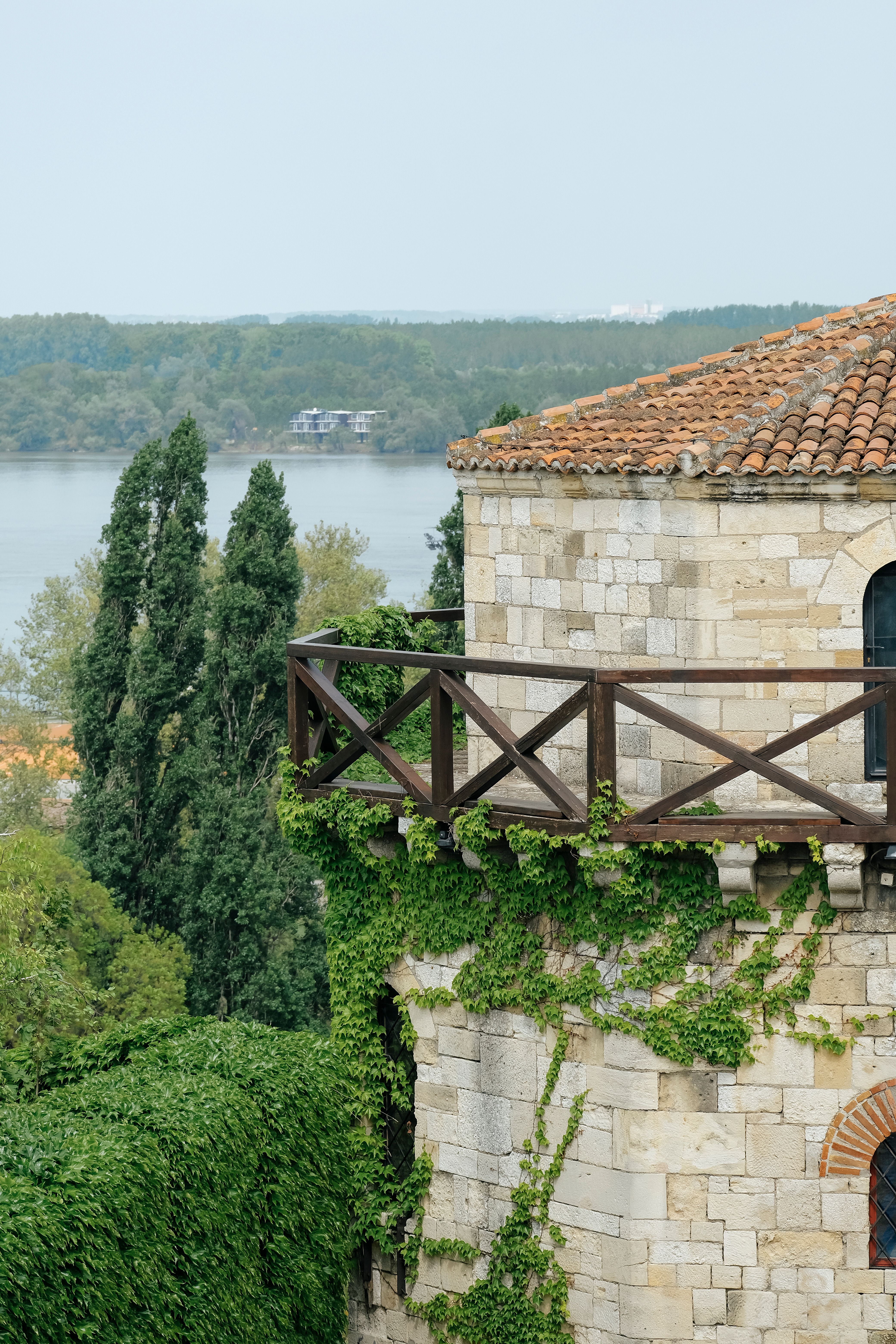 A tower with a balcony overlooking the water · Free Stock Photo
