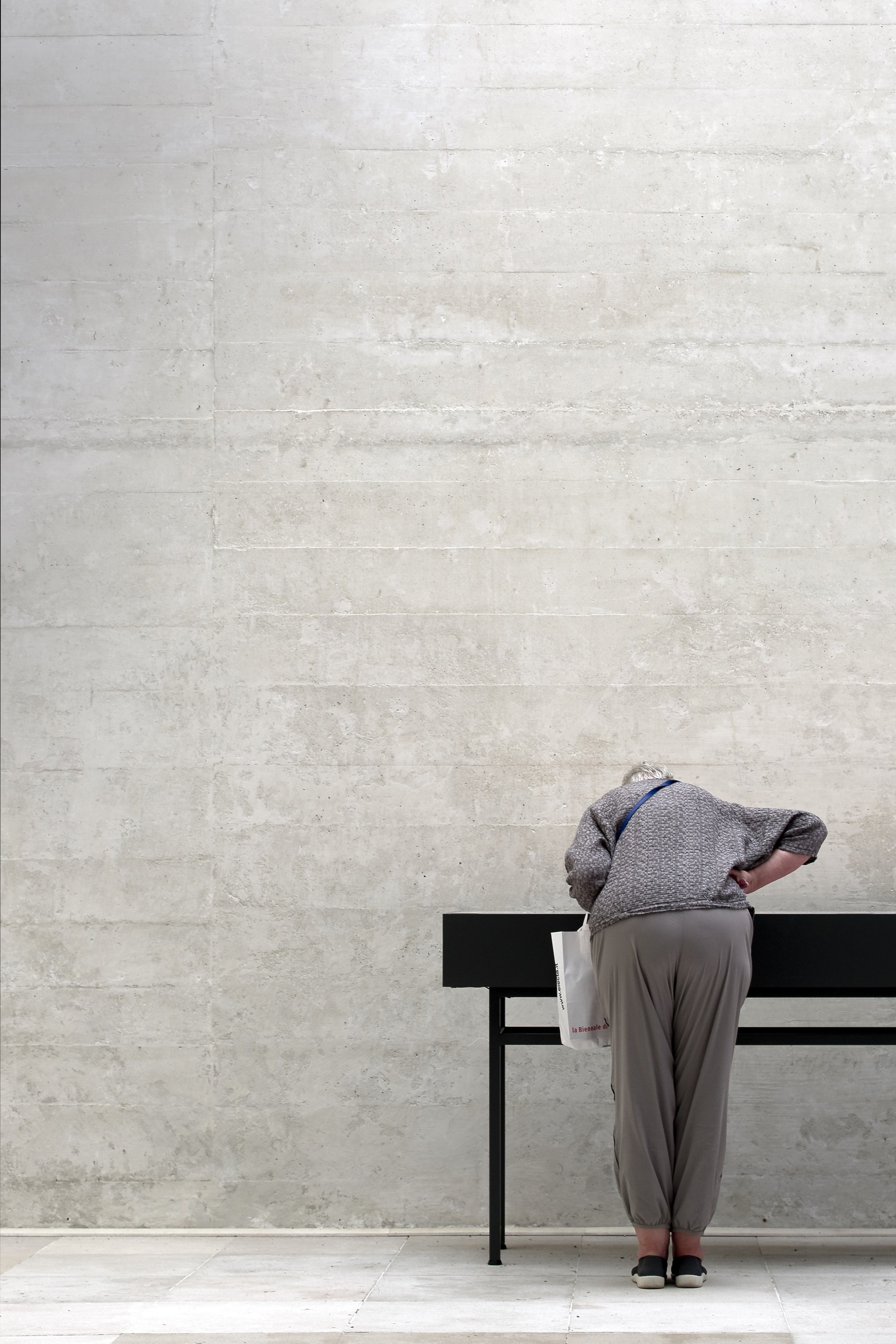 Person Bending over Table · Free Stock Photo