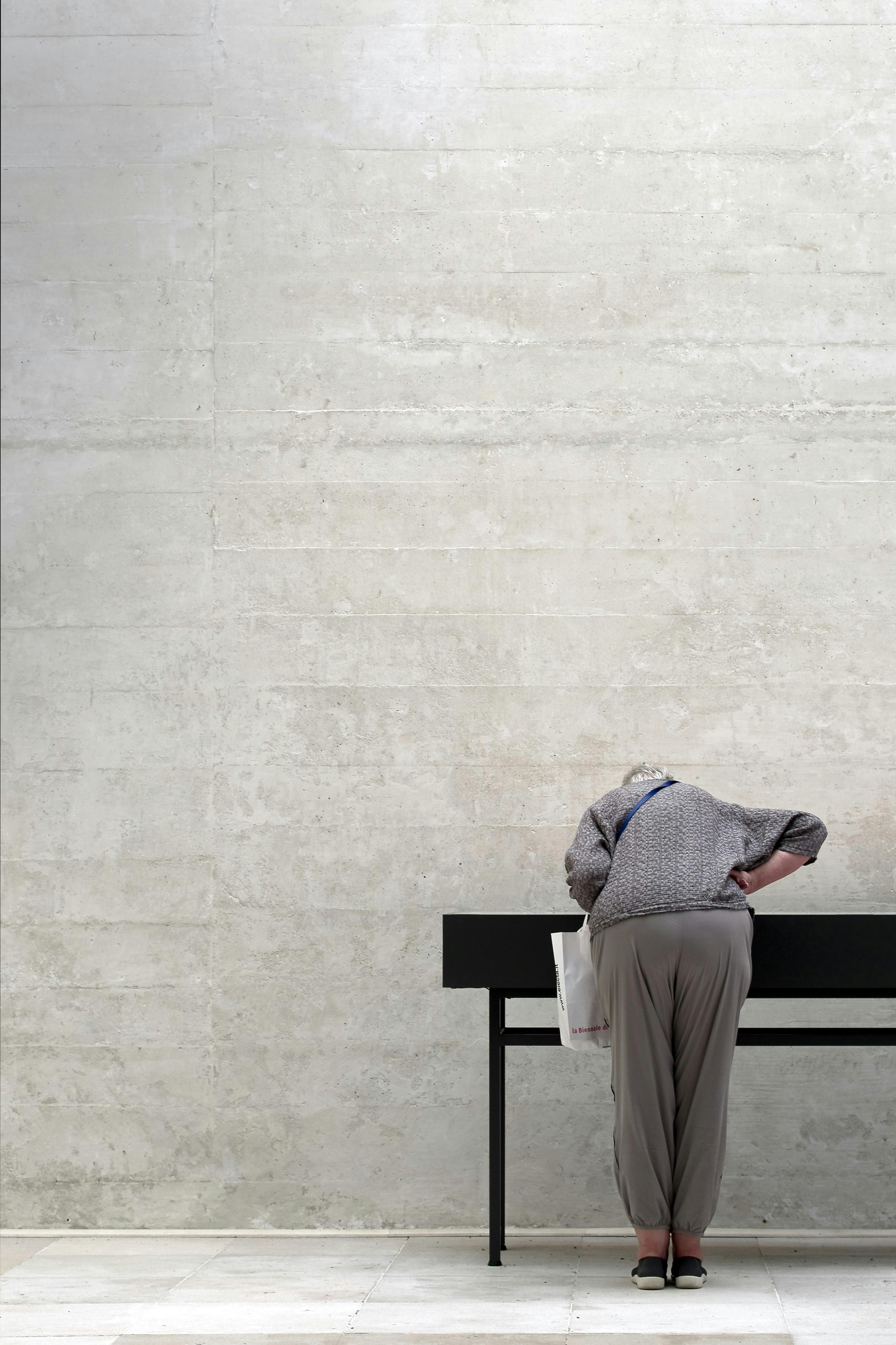 Person Bending over Table · Free Stock Photo