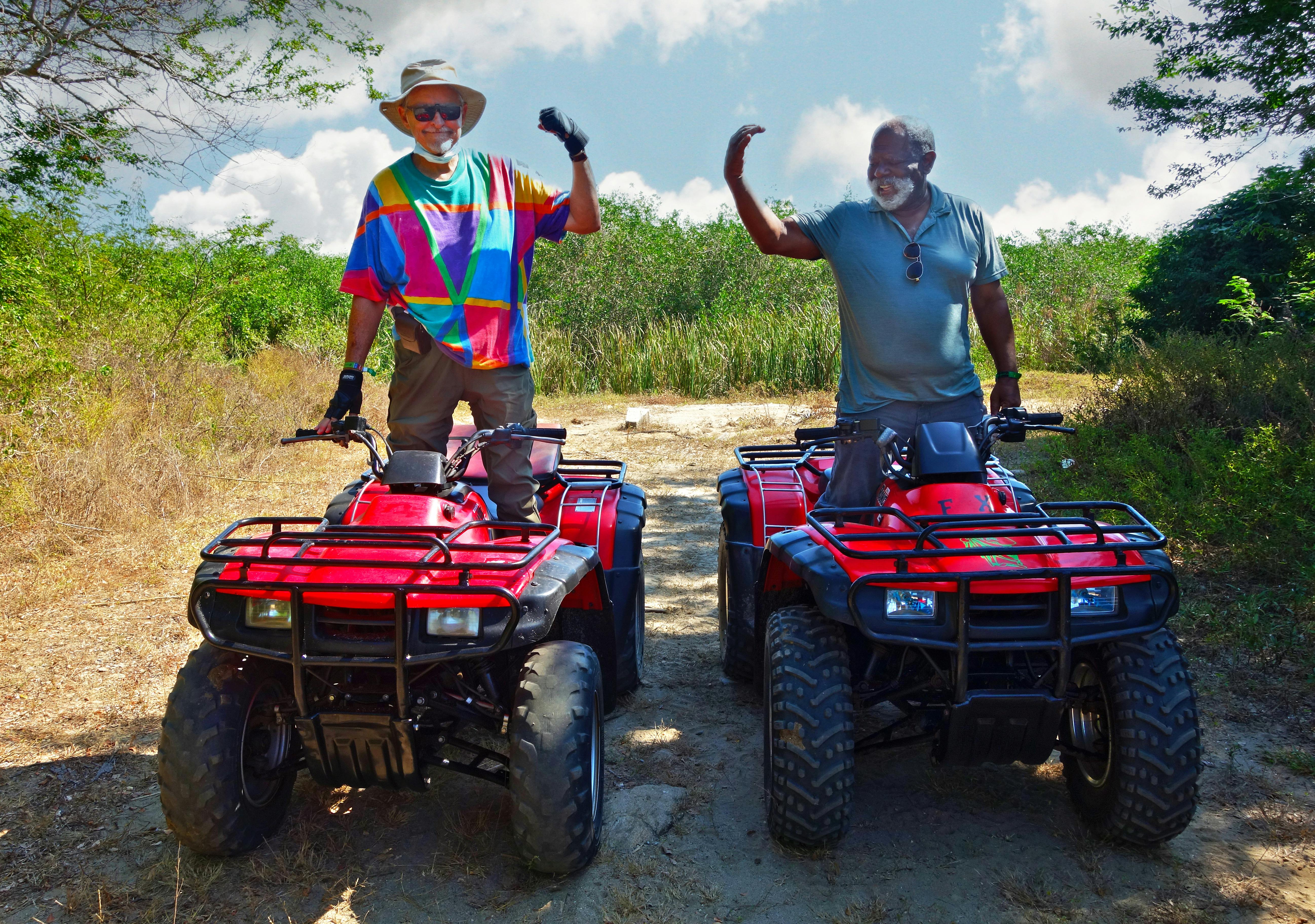 Men Standing on Quads on Dirt Road · Free Stock Photo
