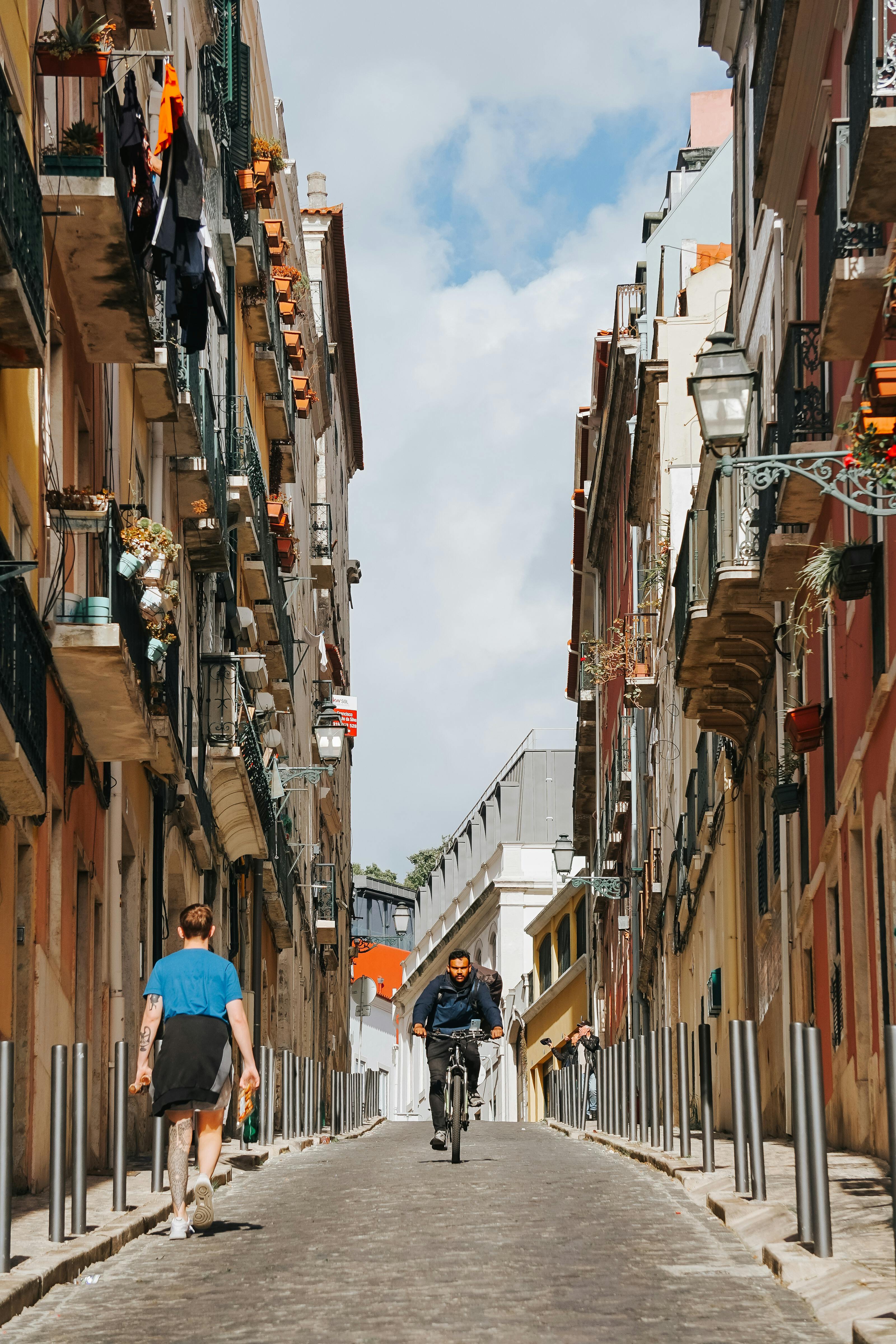 Person Walking Between of Houses · Free Stock Photo