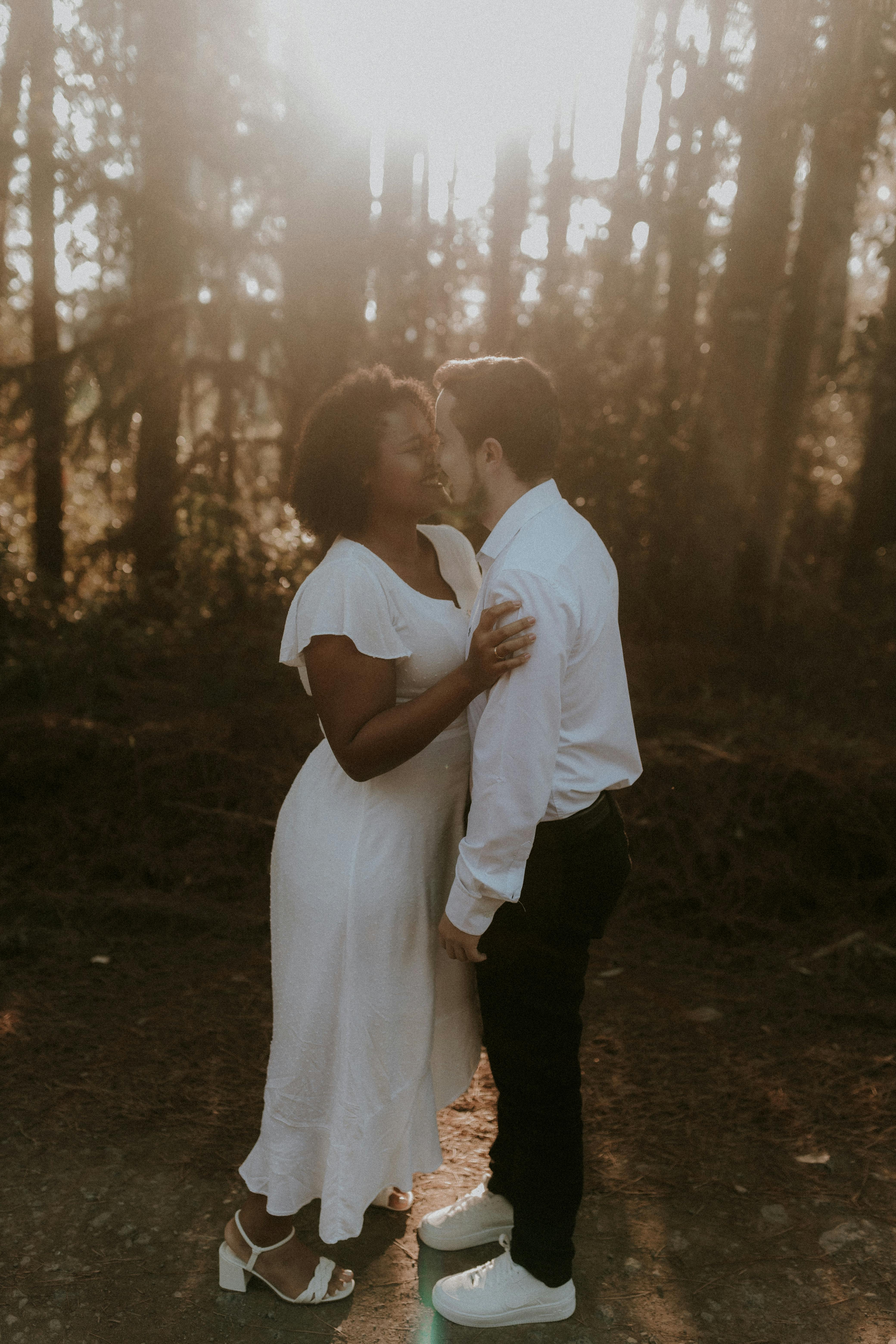 Couple Kissing in Forest Wearing Elegant Clothing · Free Stock Photo