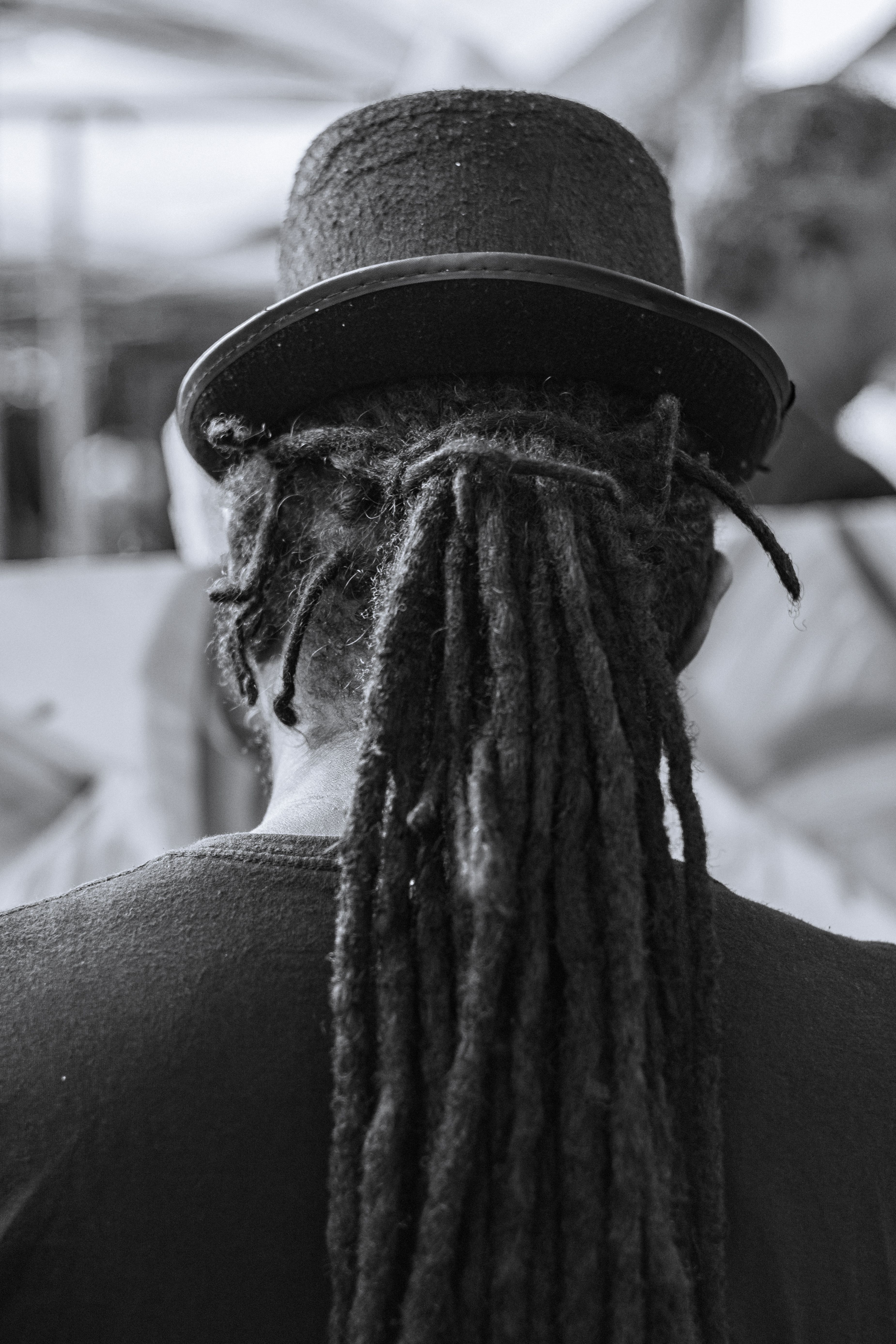 A man with dreadlocks wearing a top hat · Free Stock Photo