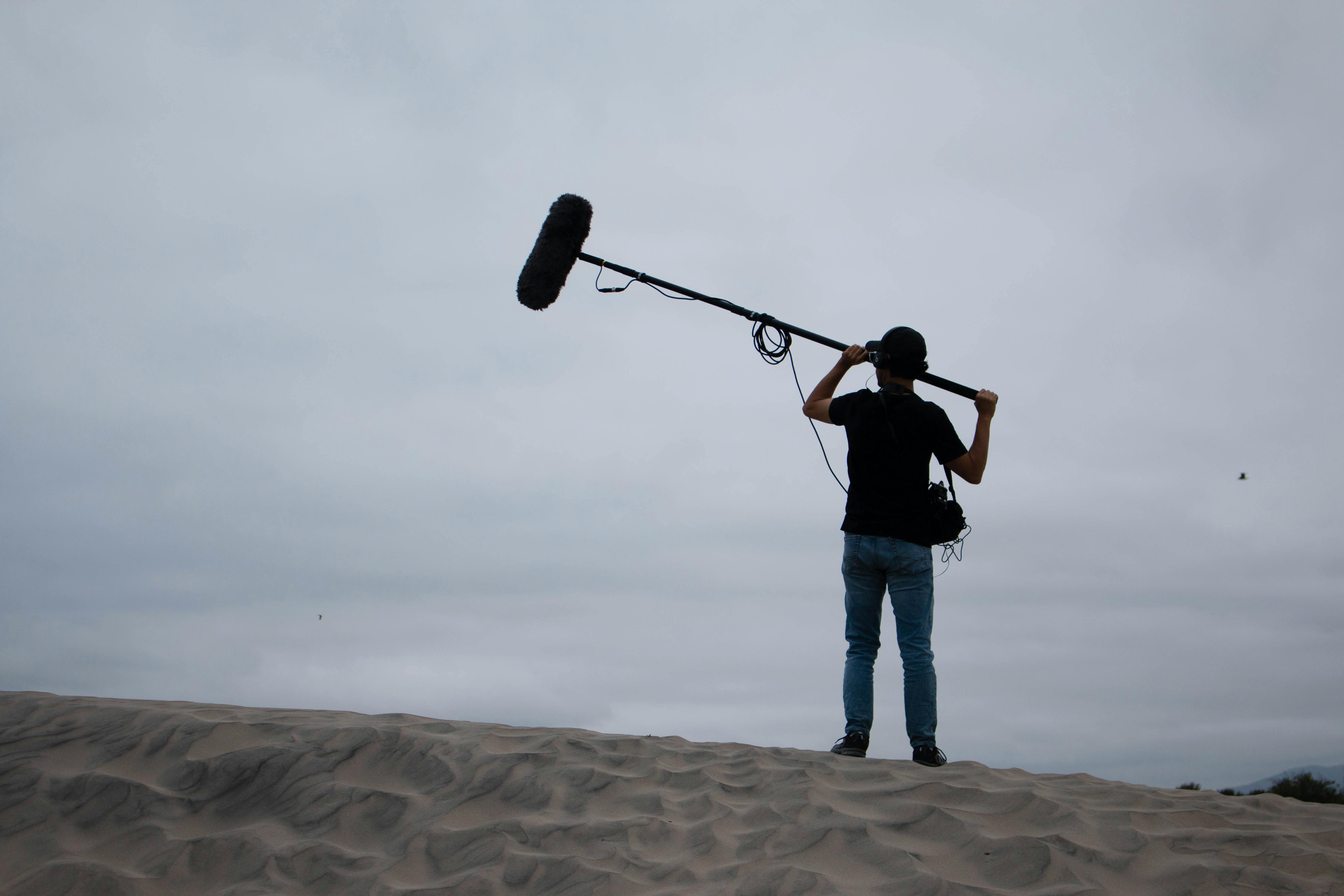 Boom Operator Standing on a Sand Dune · Free Stock Photo