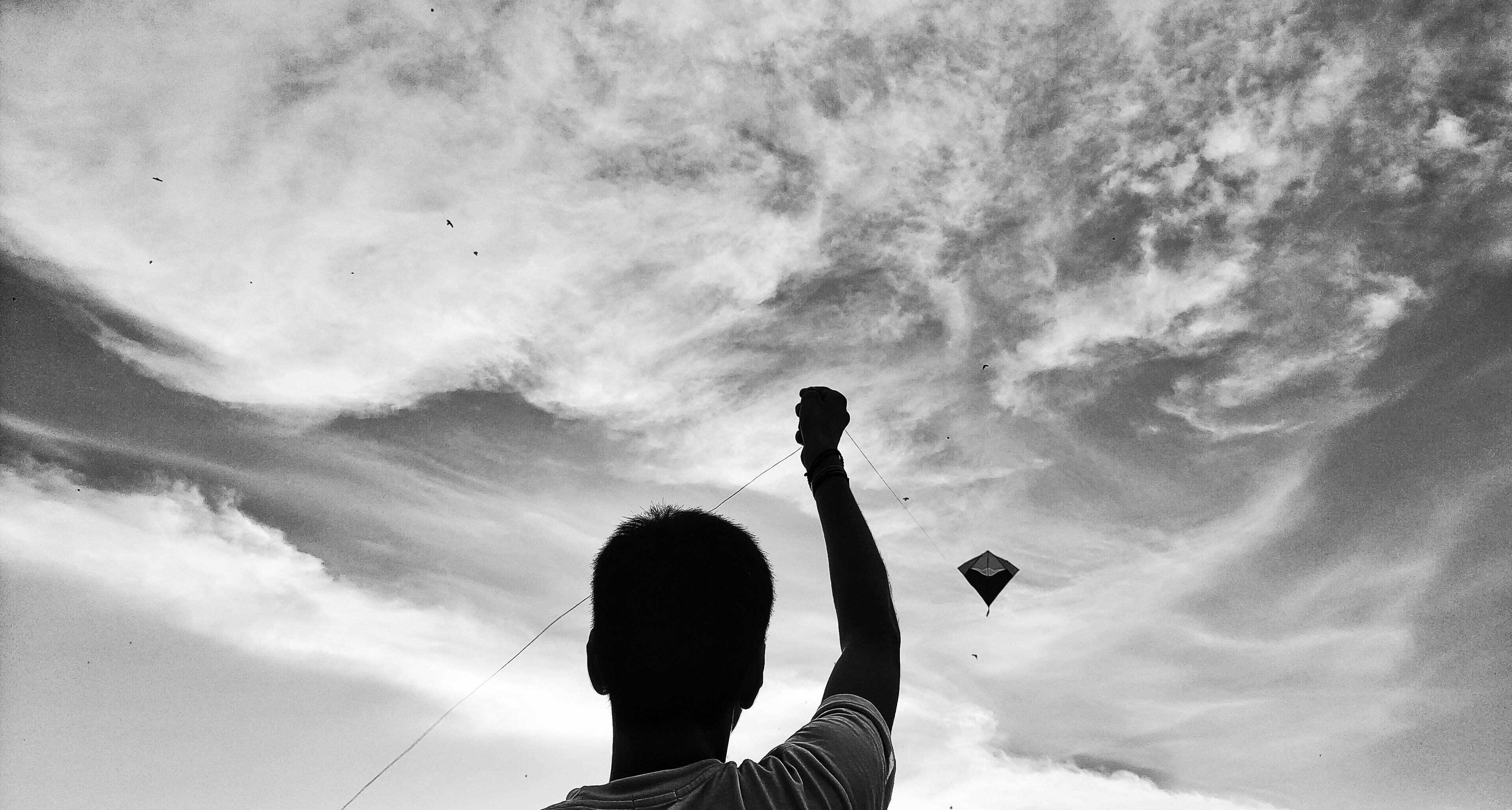 Black and White Photography of a Person Flying a Kite · Free Stock Photo