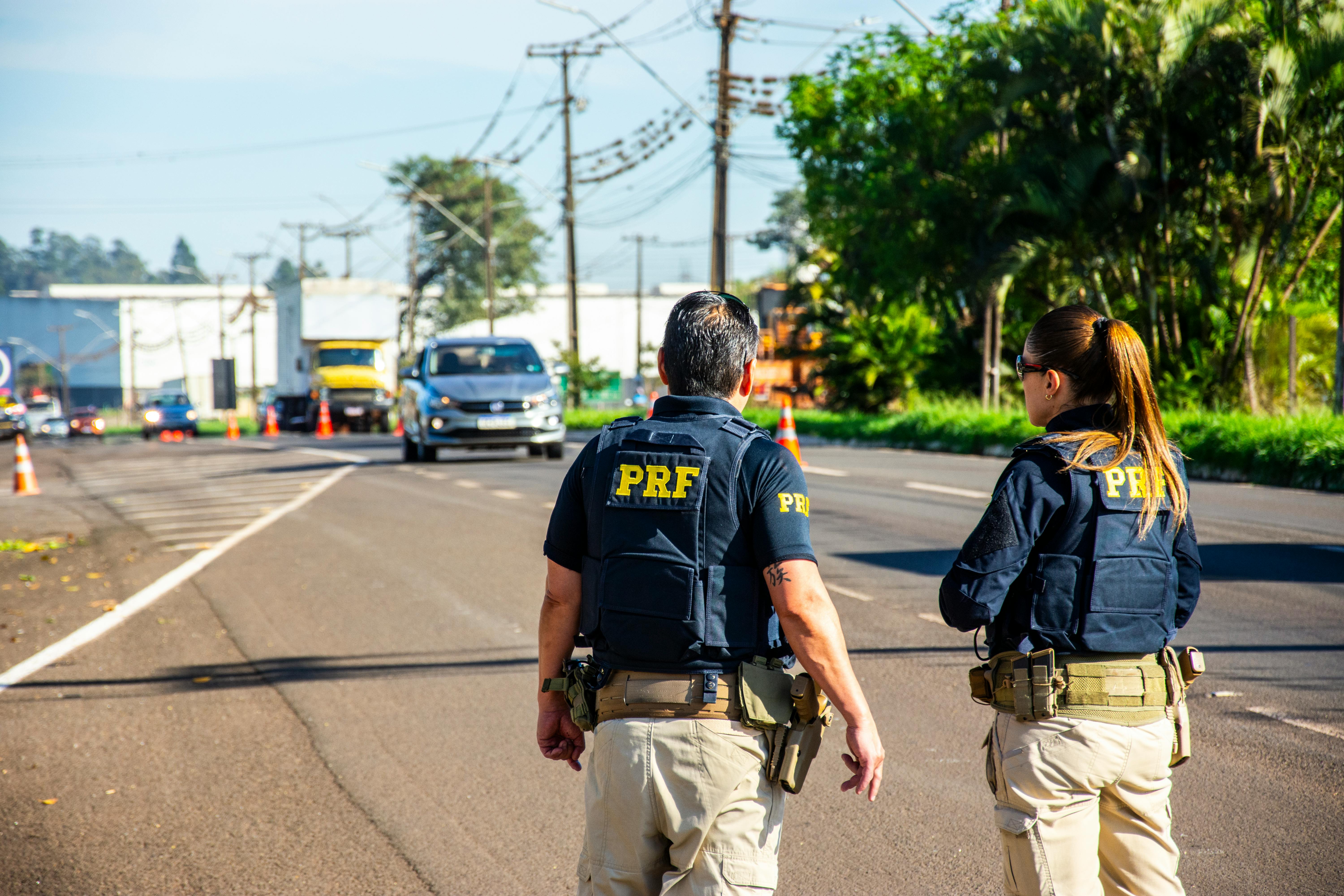 Back View of Police Officers Standing on a Street · Free Stock Photo