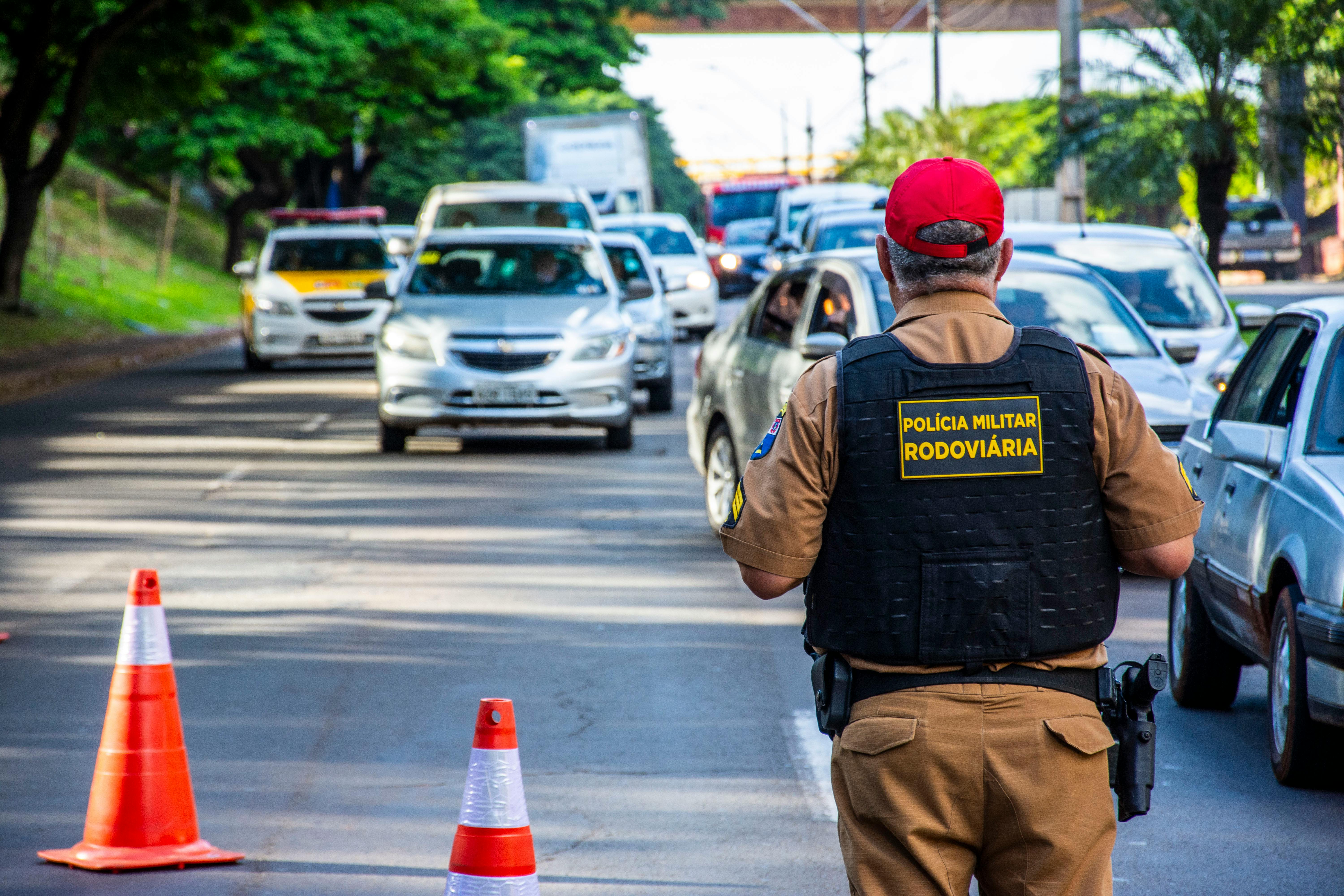 Police Officer Closing Part of a Busy Street · Free Stock Photo