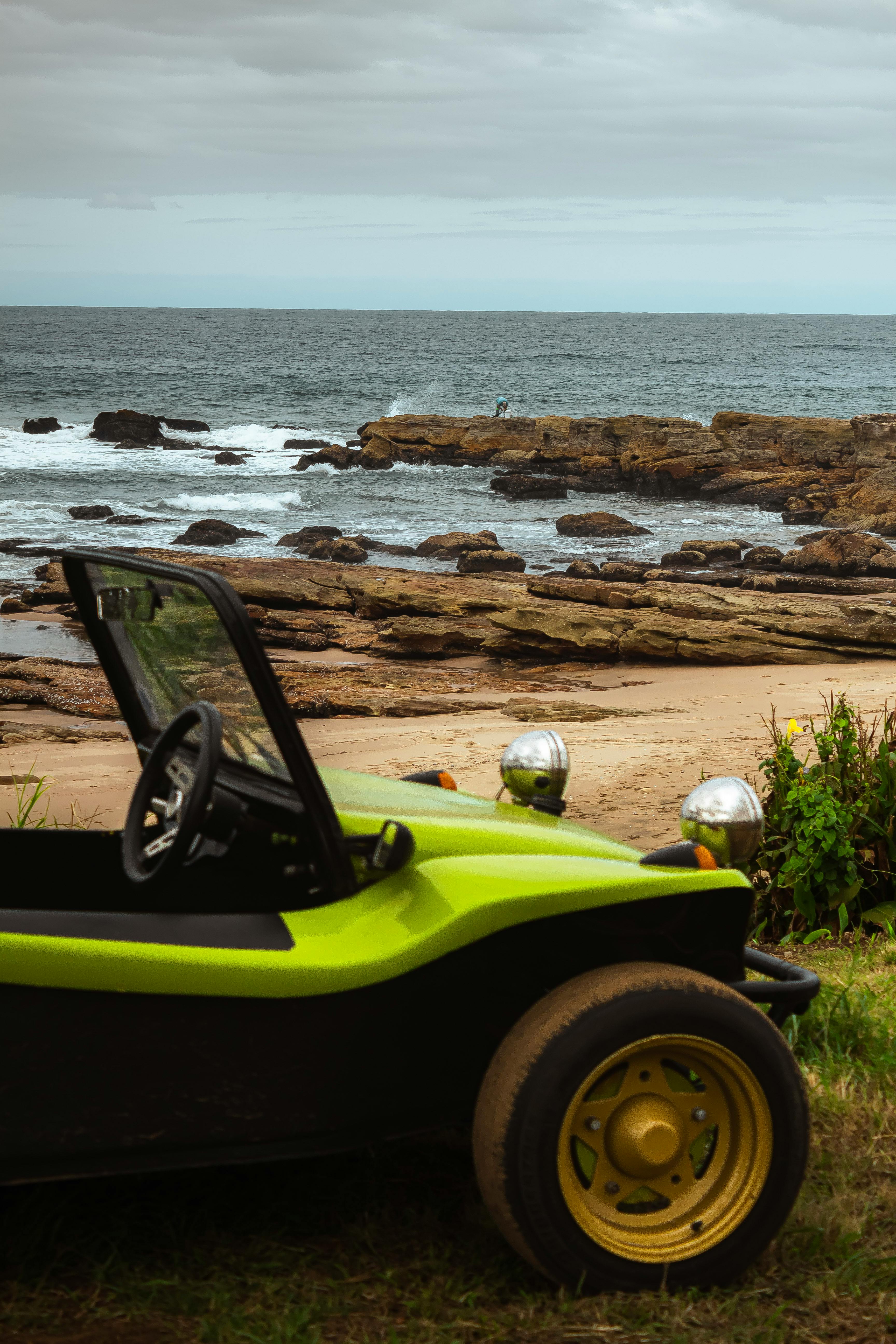 Green Dune Buggy Car Parked on Beach with Stone Coast · Free Stock Photo