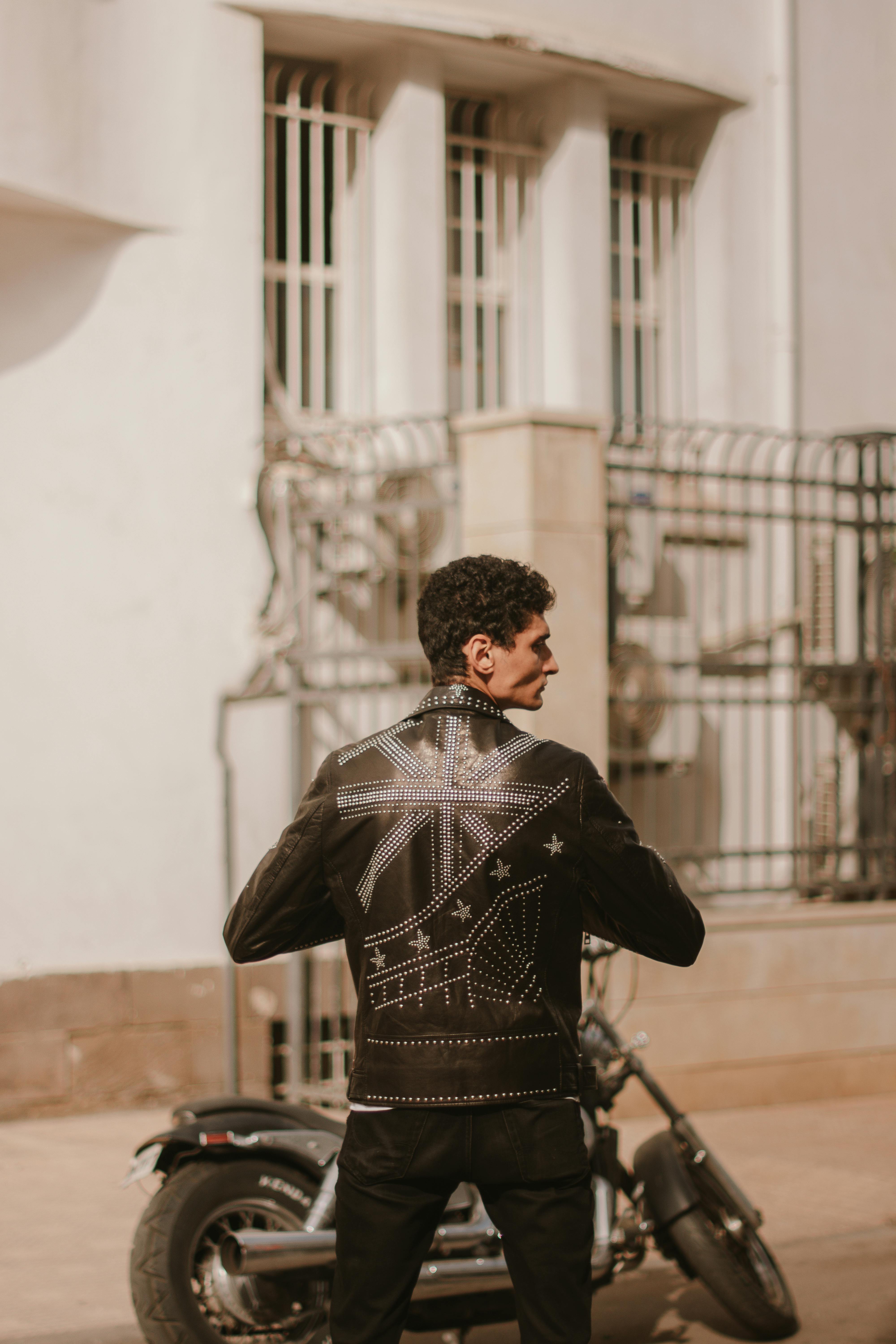 Back View of Man Wearing Leather Jacket with Zirconias Standing in ...