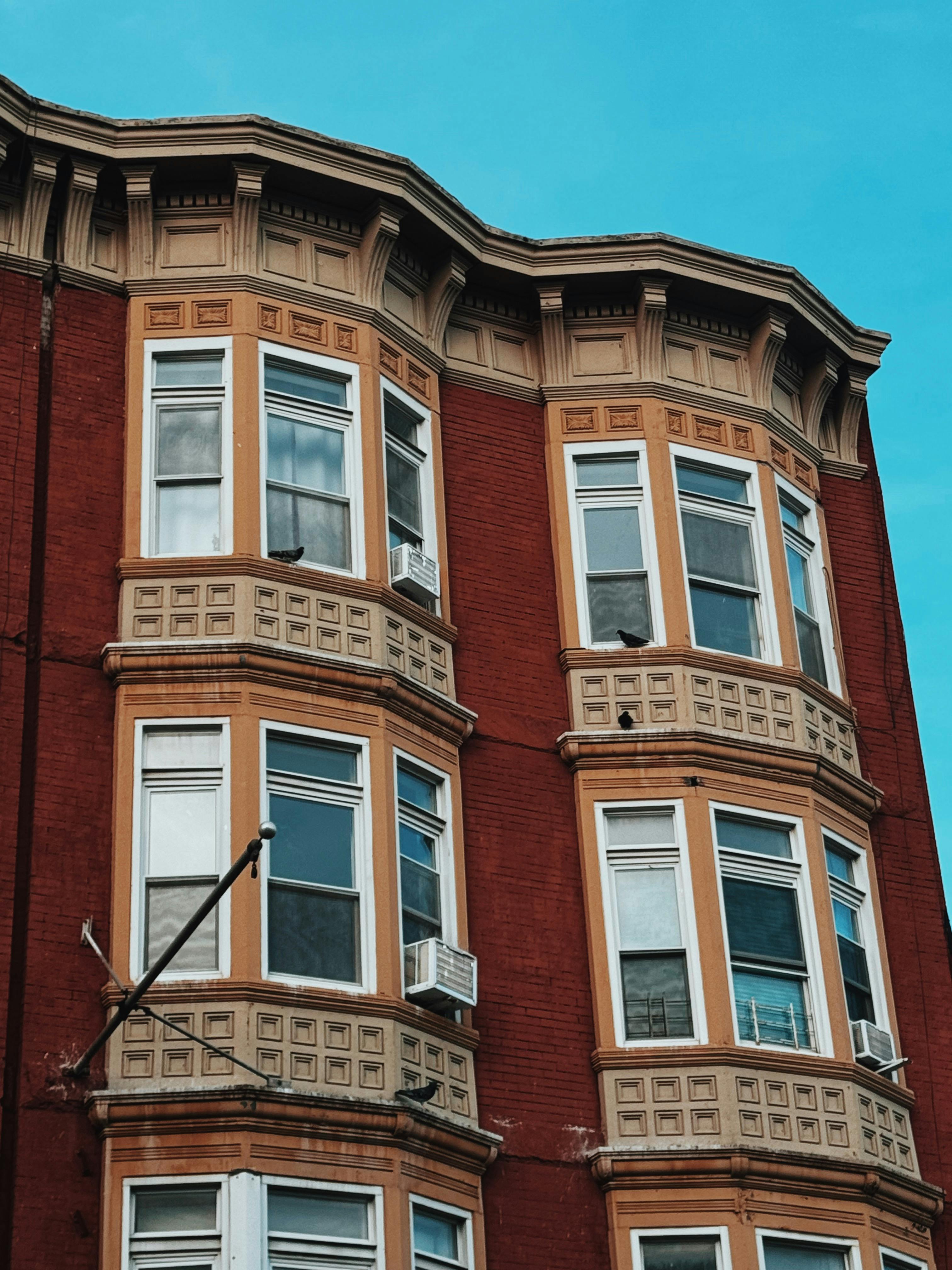 Old Red Brick Tenement Building with Convex Windows · Free Stock Photo