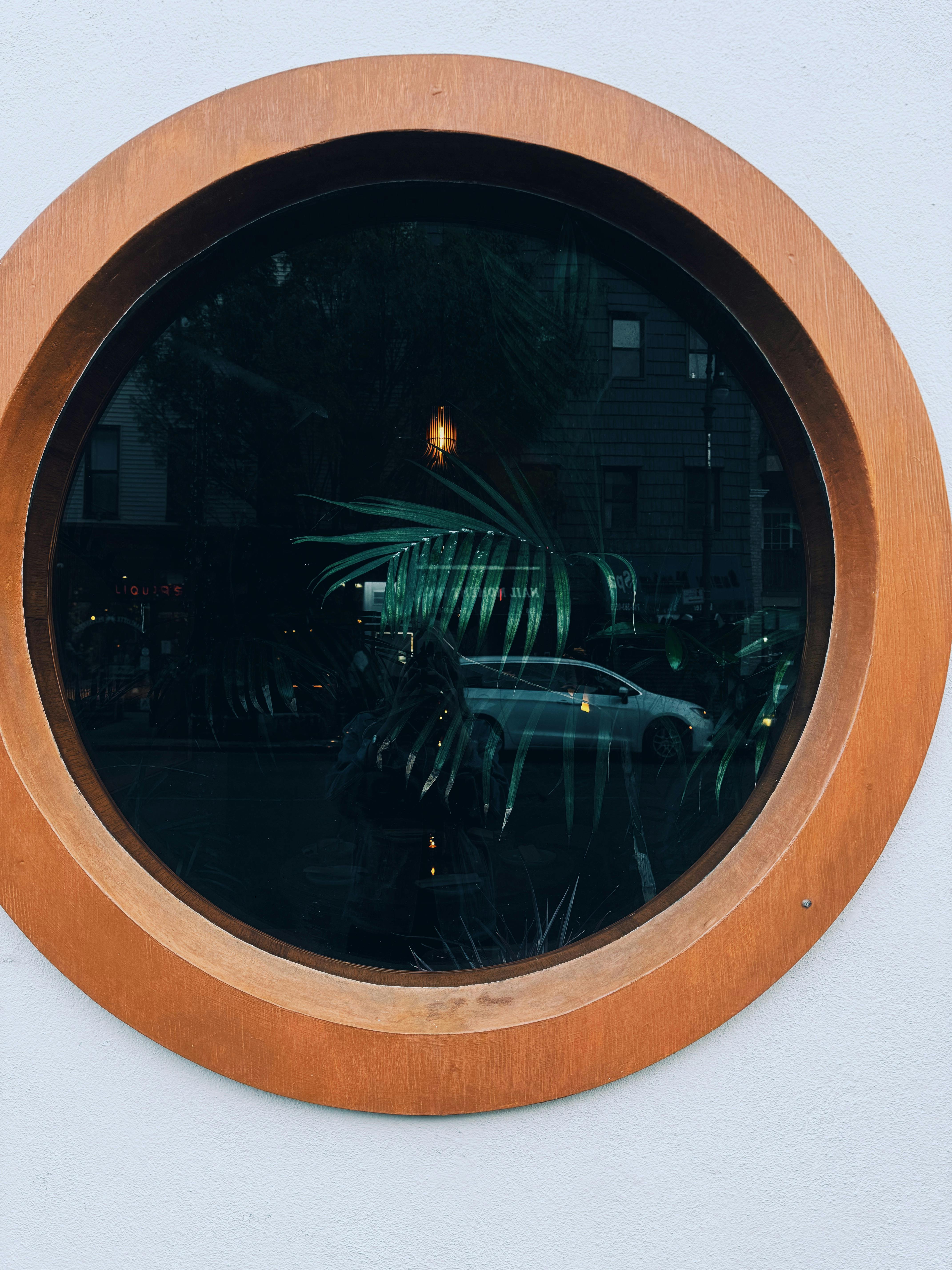 A Car Reflected in a Round Window · Free Stock Photo