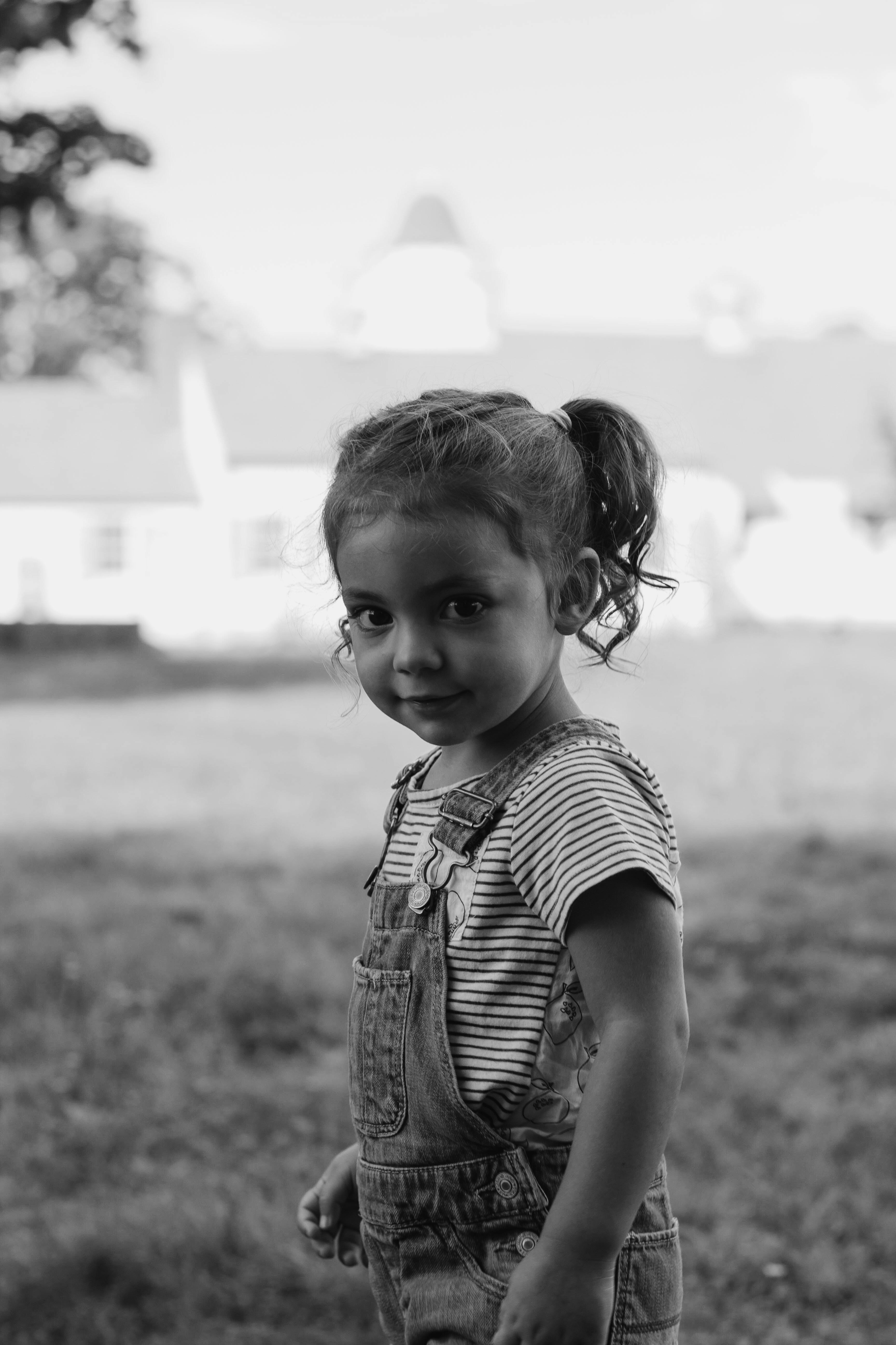 Little Girl with a Ponytail in Dungarees · Free Stock Photo