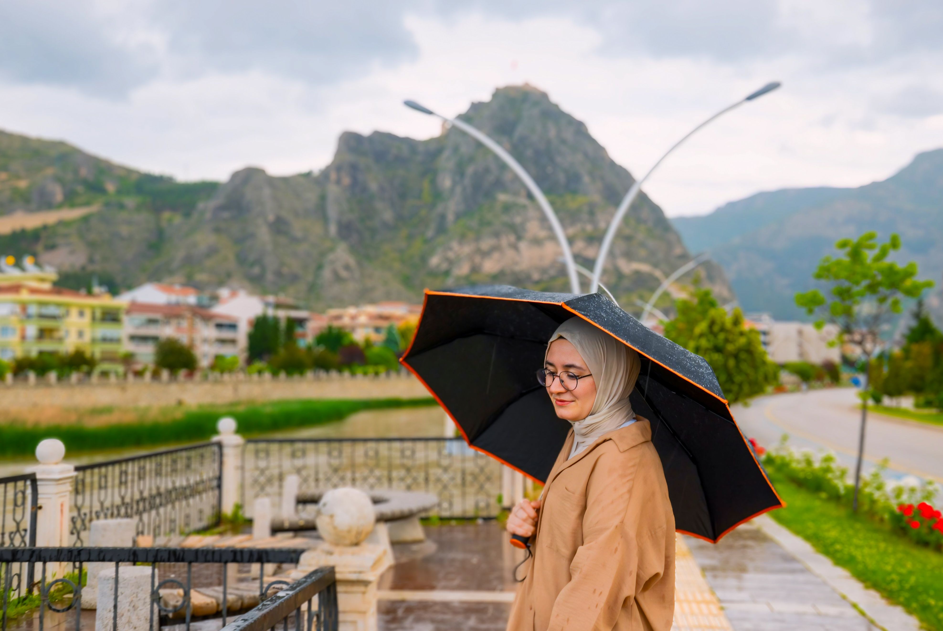 A woman with an umbrella standing in front of a building · Free Stock Photo