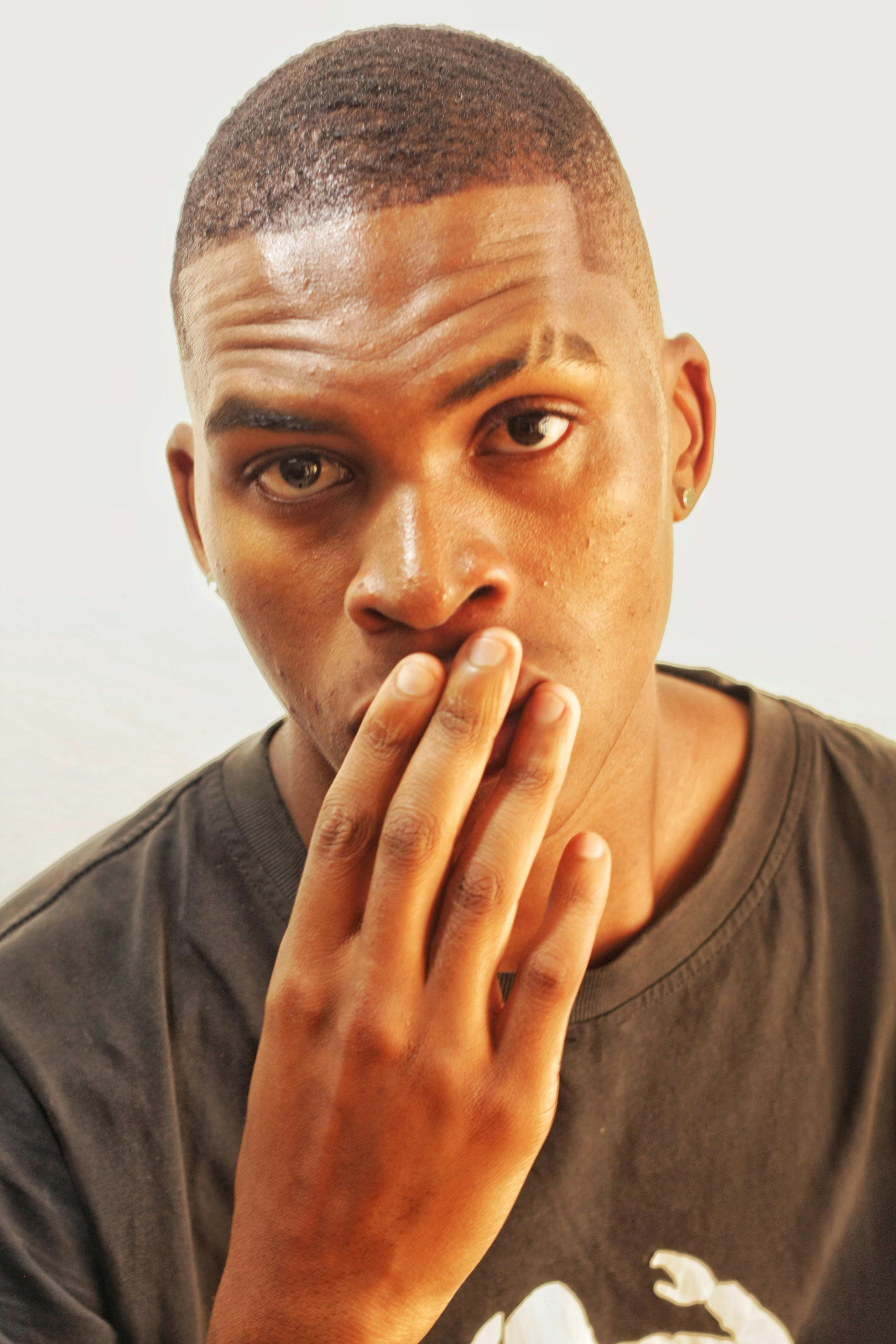 Portrait of Man with Hand over Mouth · Free Stock Photo